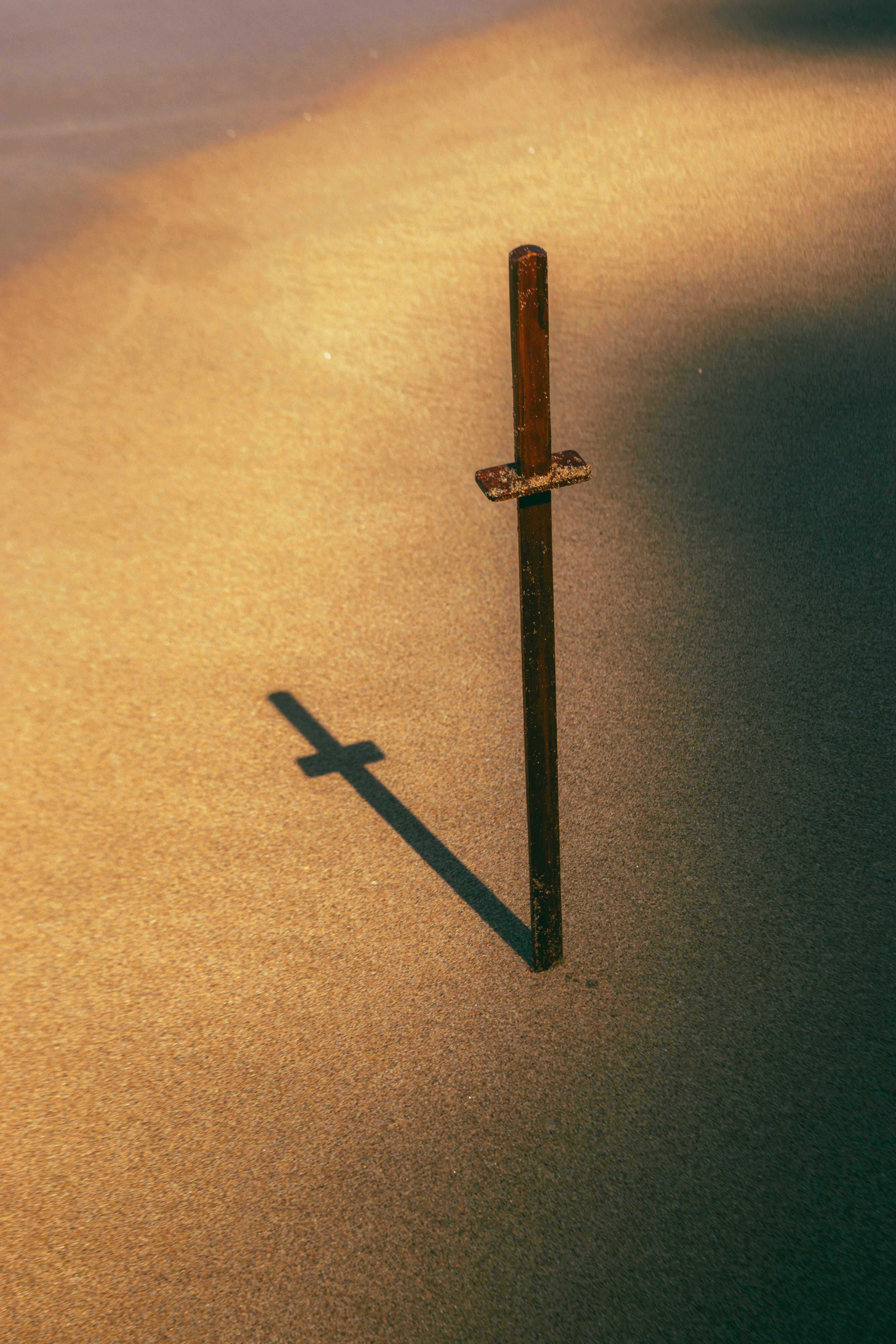 Rusty Metal Post Casting Shadow on Sand · Free Stock Photo