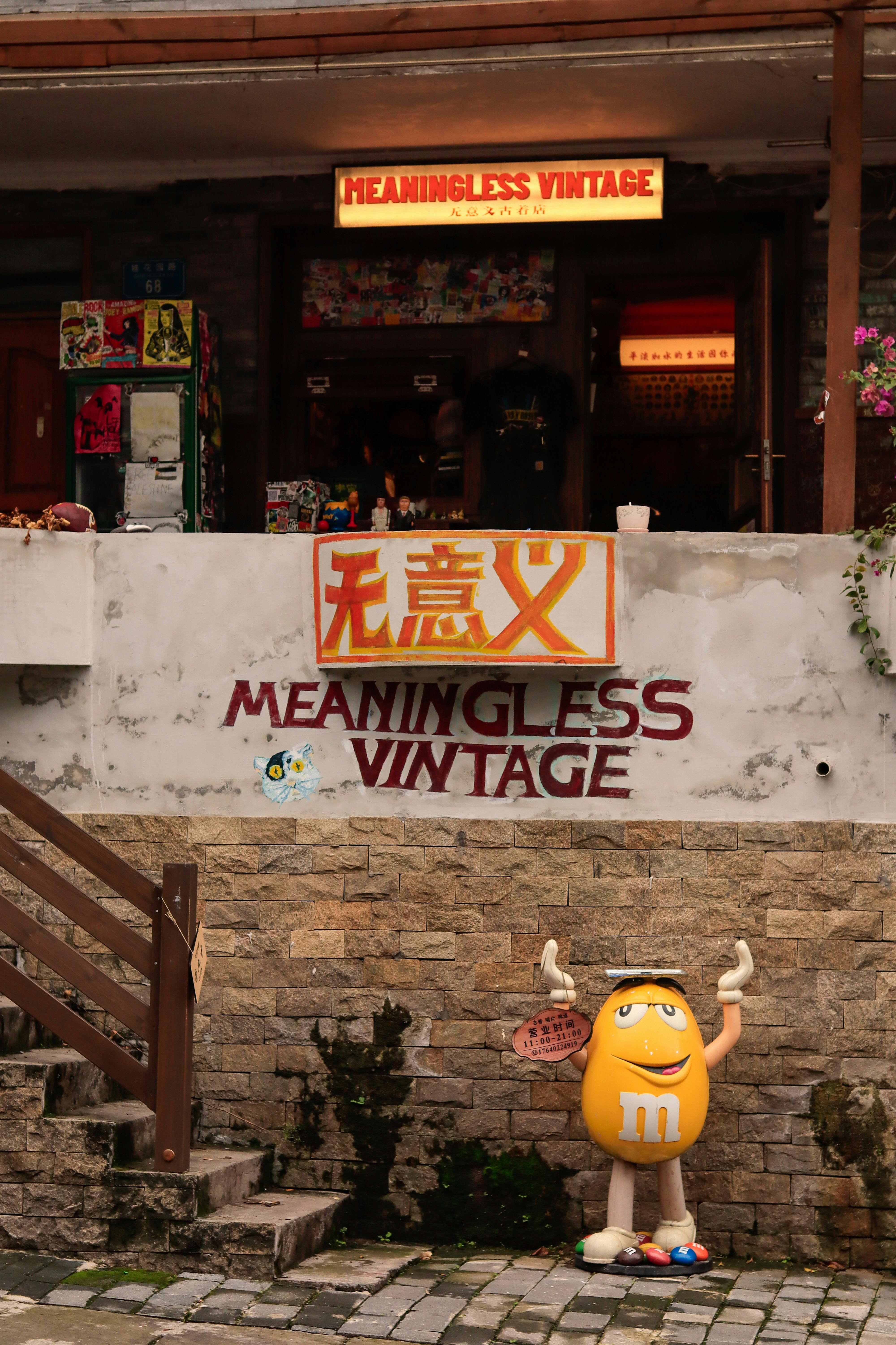 Quirky Vintage Shopfront with Yellow Mascot · Free Stock Photo