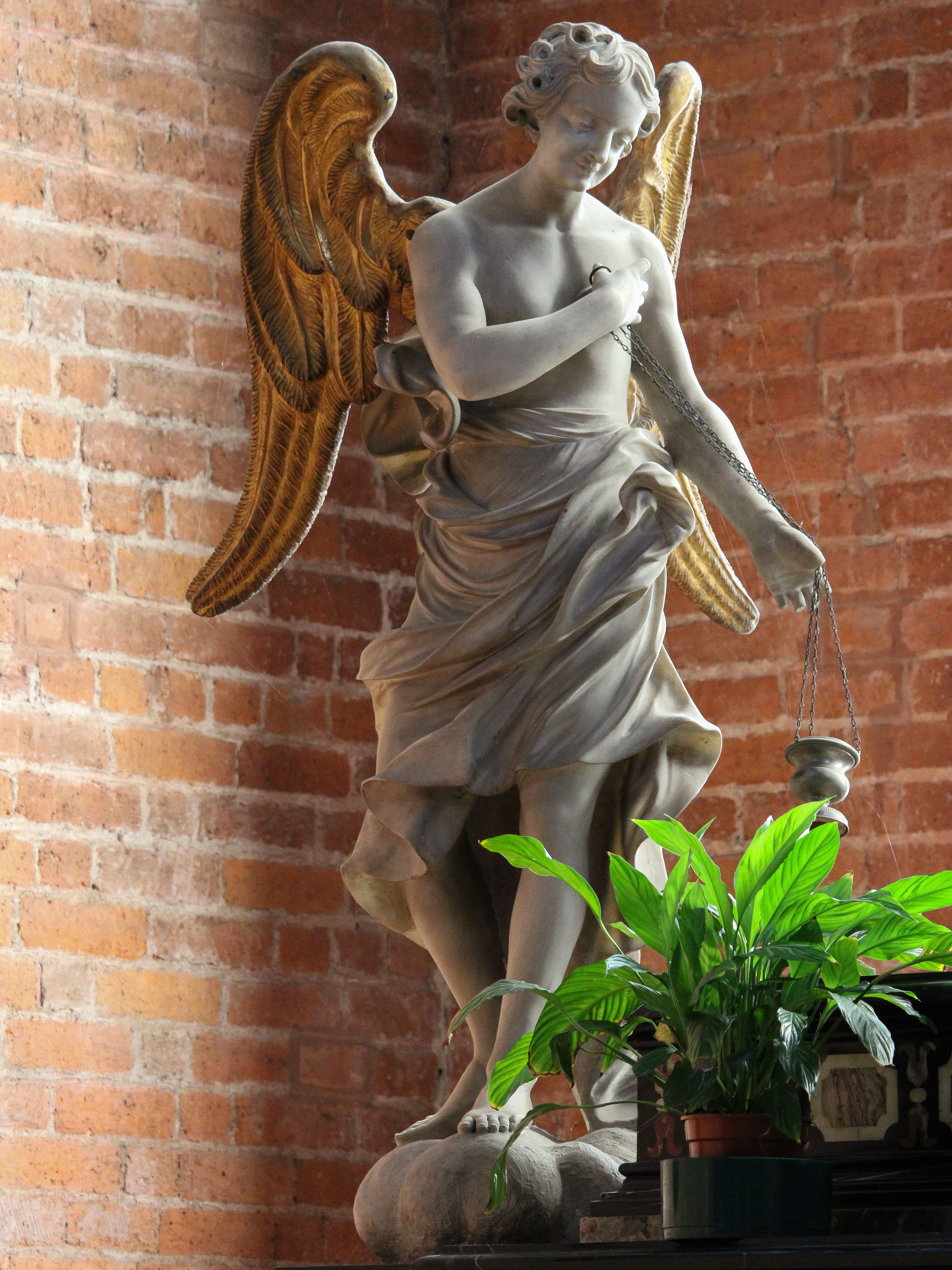 Elegant Angel Statue in Brick Interior · Free Stock Photo