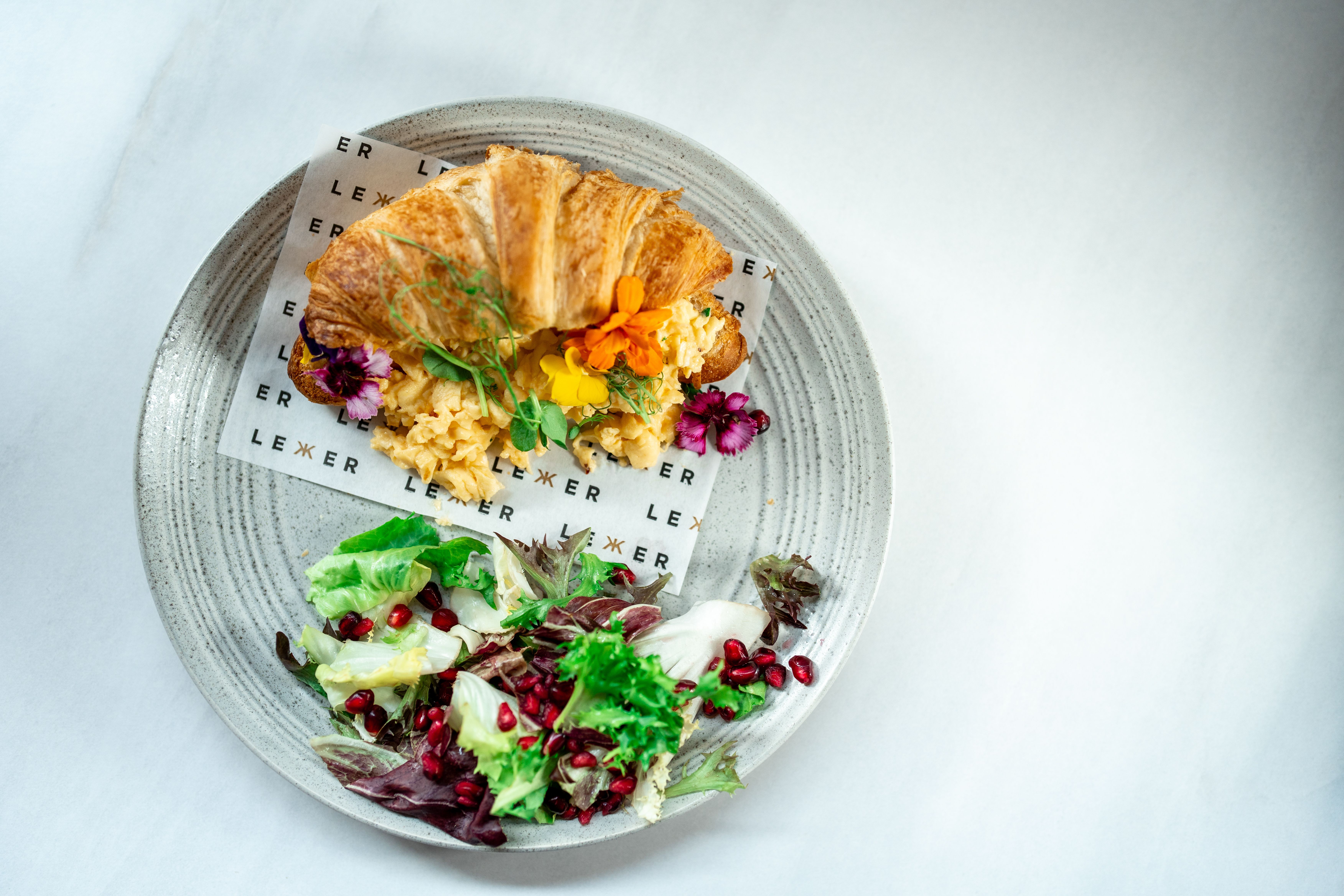 Elegant Breakfast Plate with Croissant and Salad · Free Stock Photo