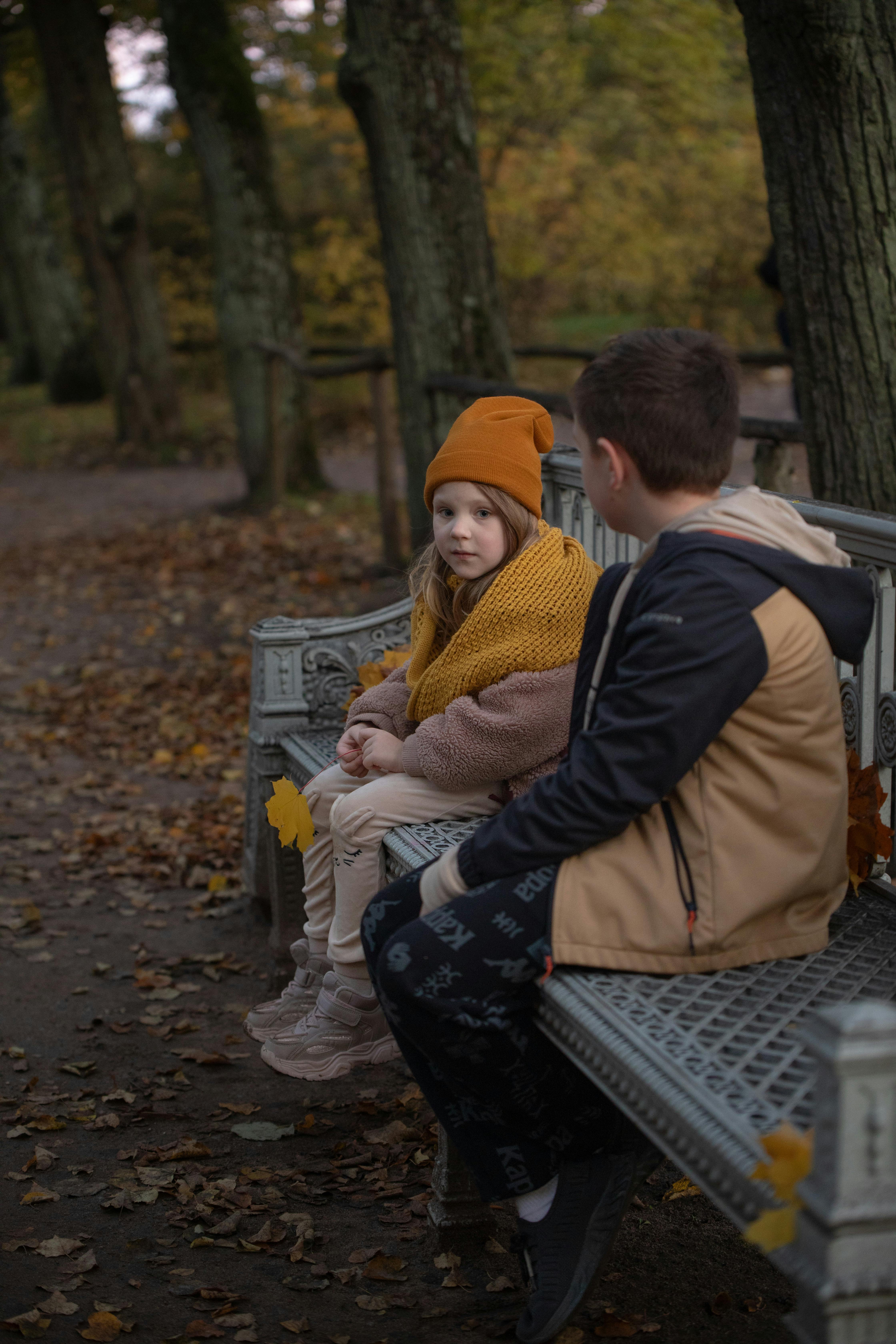 Children Sitting on Park Bench in Autumn · Free Stock Photo