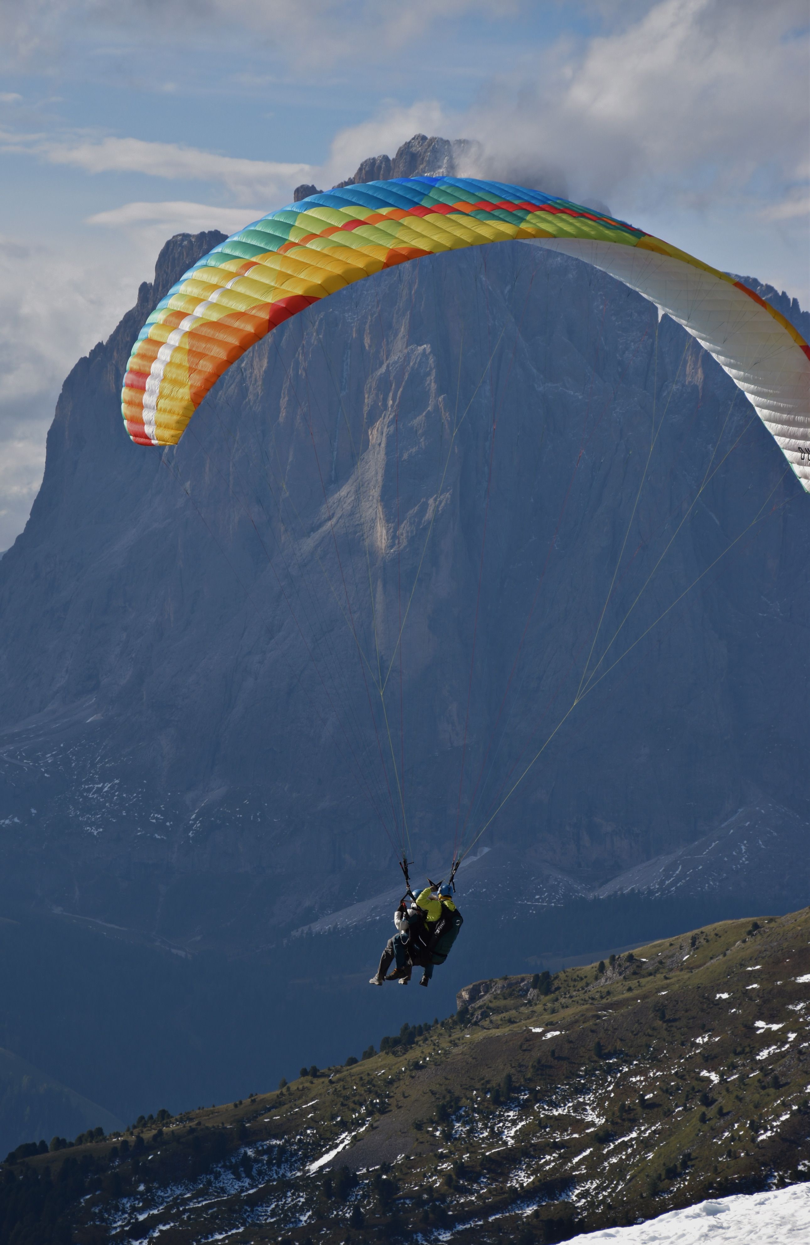 Paraglider flying over snowy mountains · Free Stock Photo