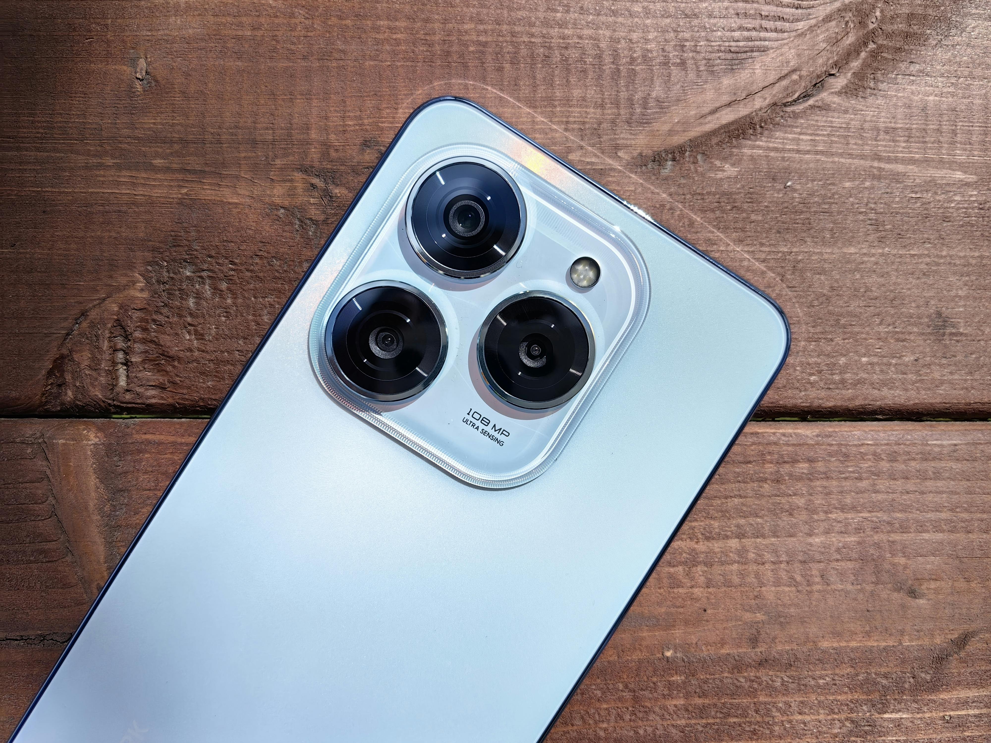 High-Resolution Smartphone Camera on Wooden Surface · Free Stock Photo