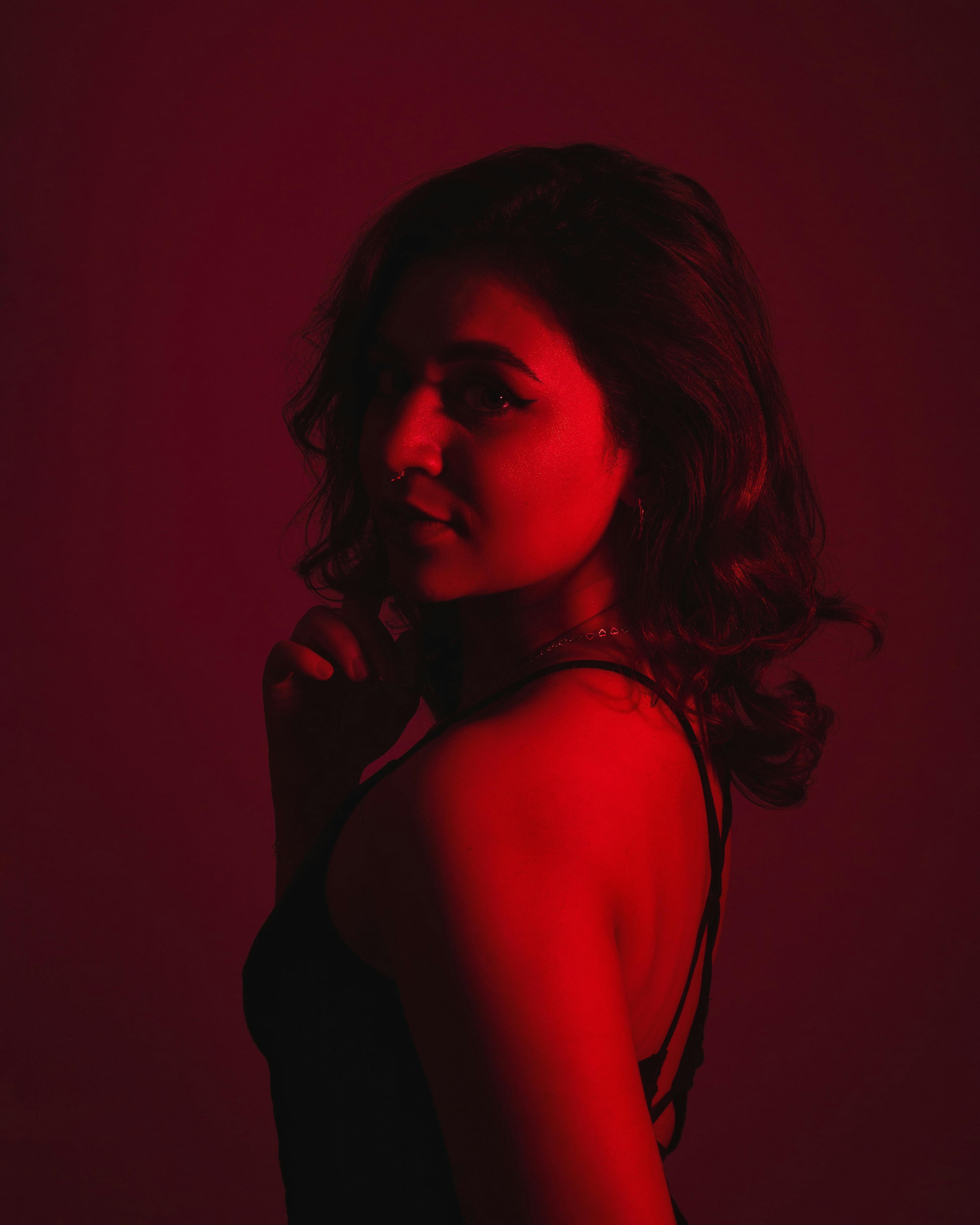 Mysterious Woman in Red Light Portrait · Free Stock Photo