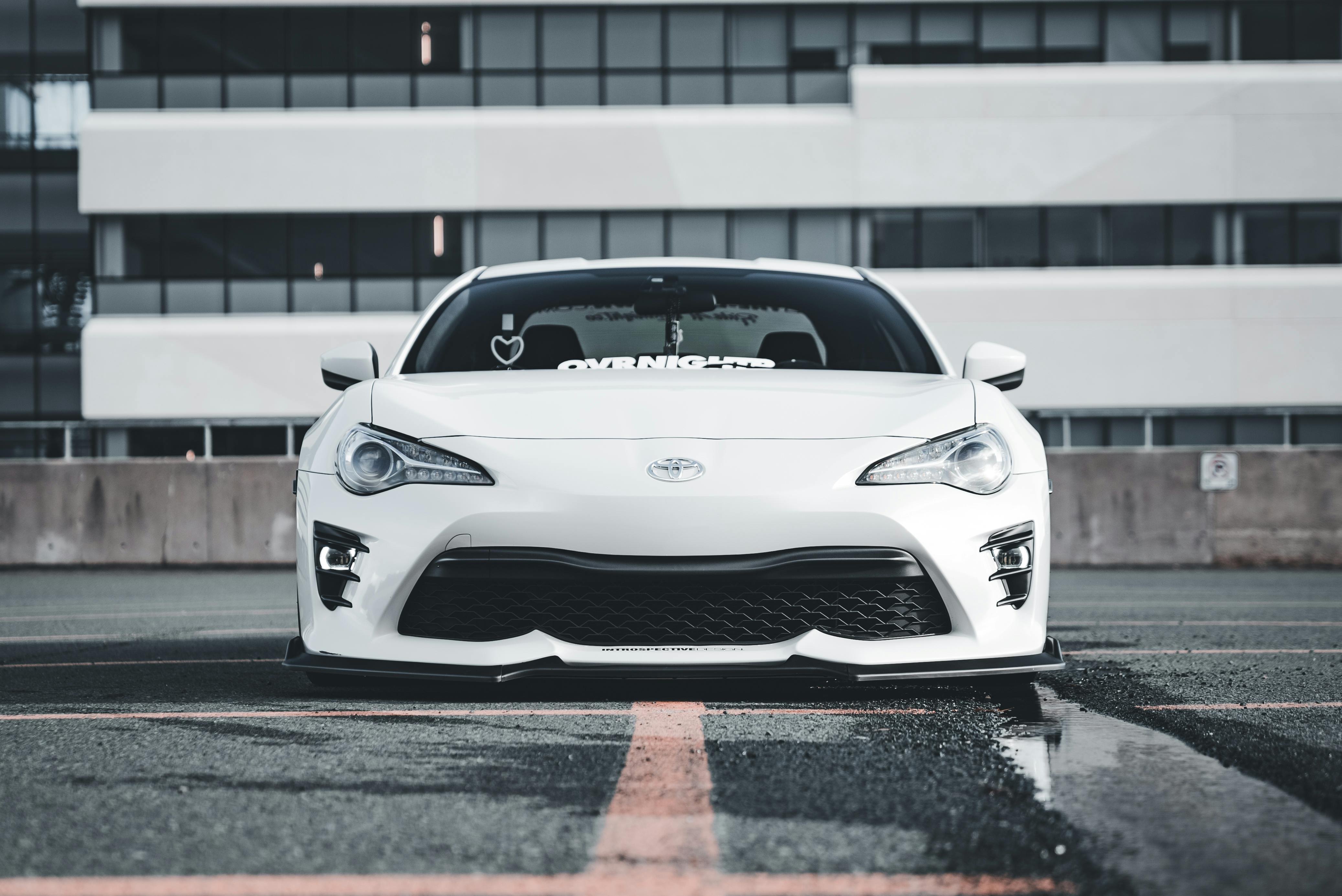 Front View of White Sports Car on Urban Street · Free Stock Photo