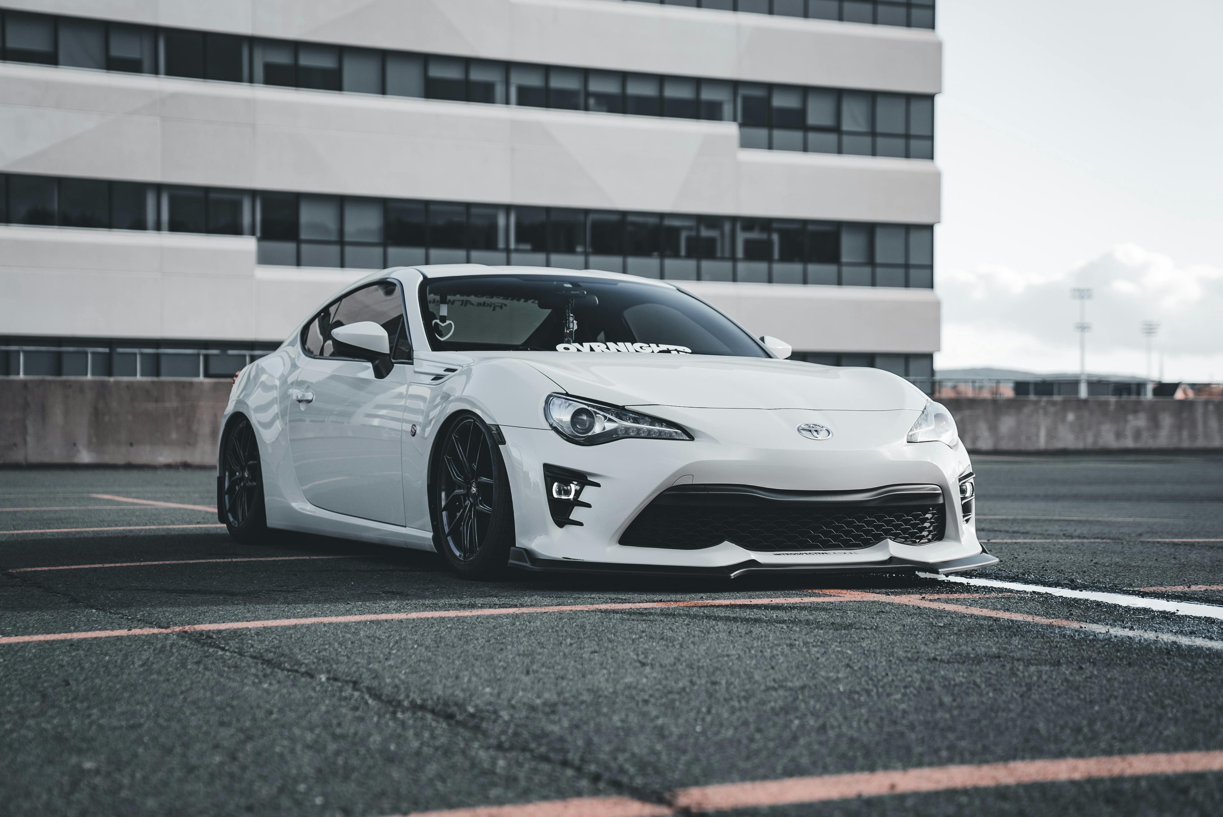 Sleek White Sports Car in Urban Setting · Free Stock Photo