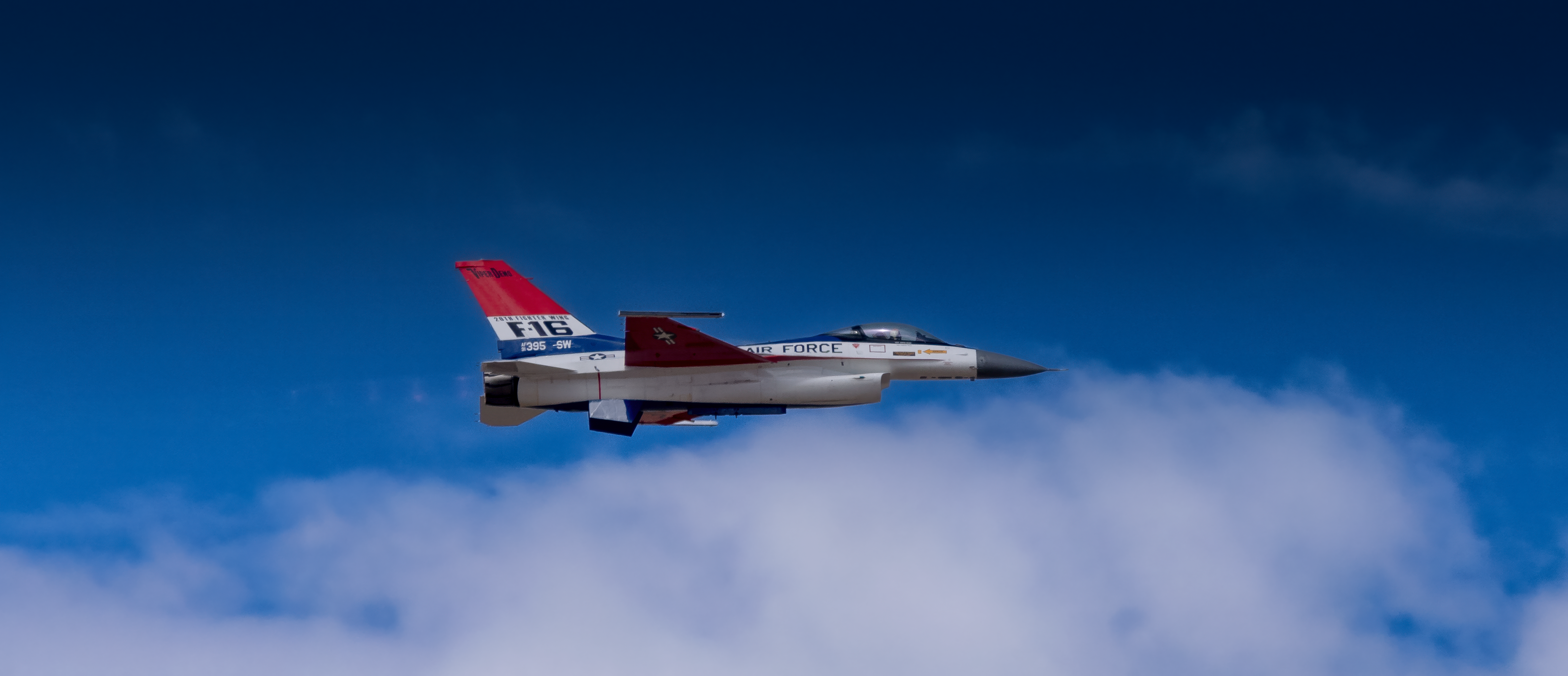 Dynamic F-16 Fighter Jet Soaring Through Blue Skies · Free Stock Photo
