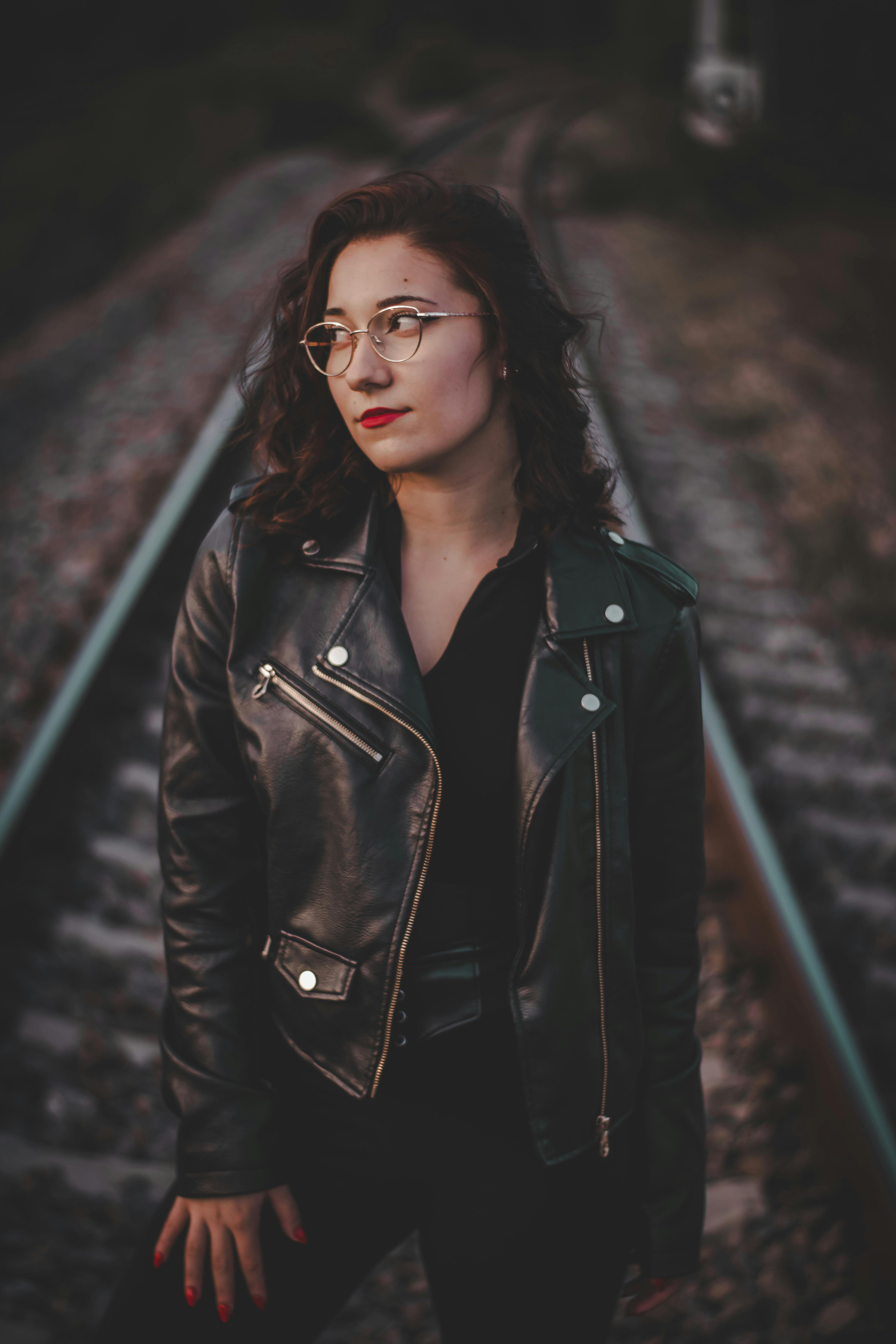 Stylish Woman in Leather Jacket on Train Tracks · Free Stock Photo