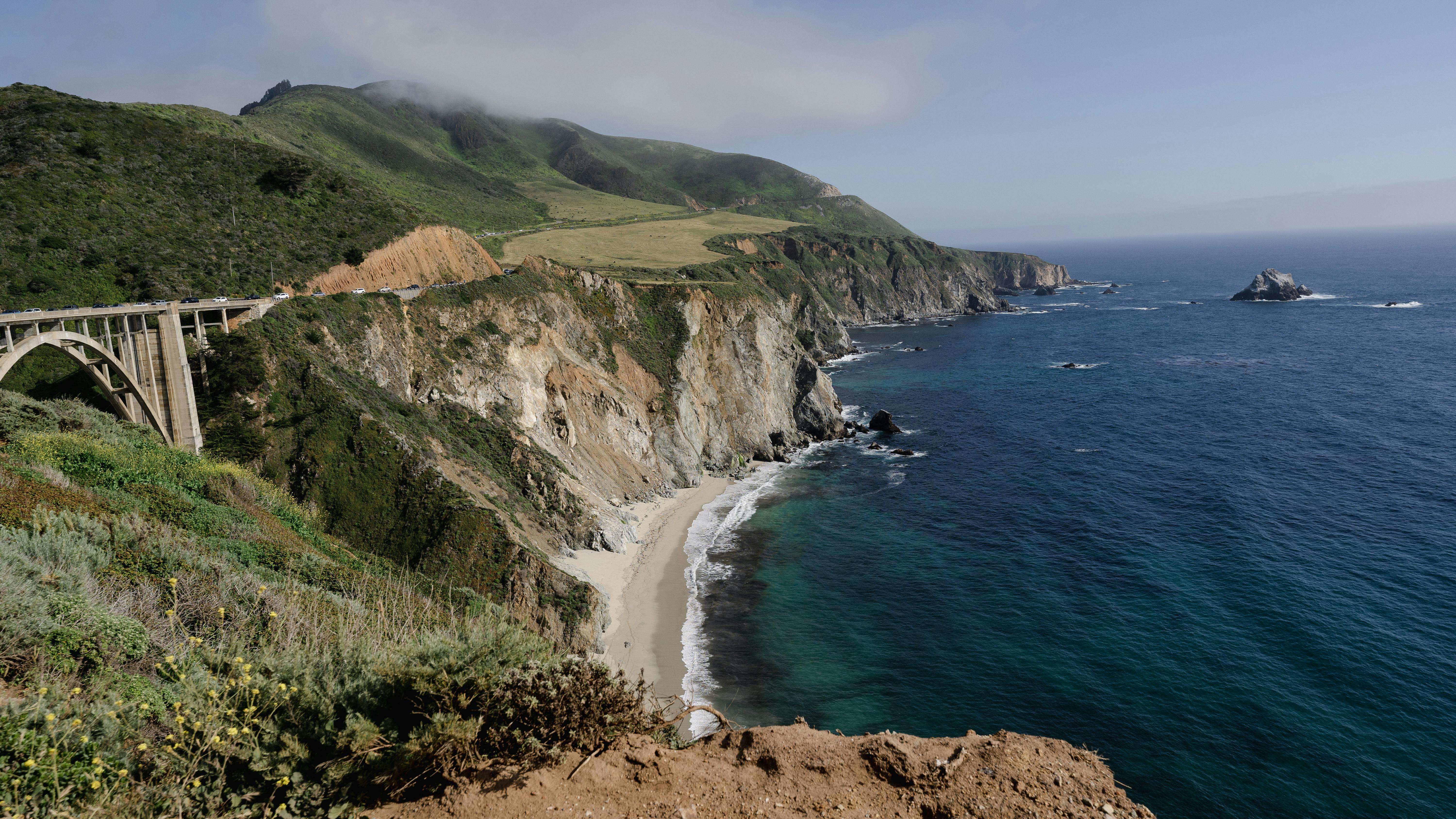 Stunning Coastal Bridge Along Rugged Cliffside · Free Stock Photo