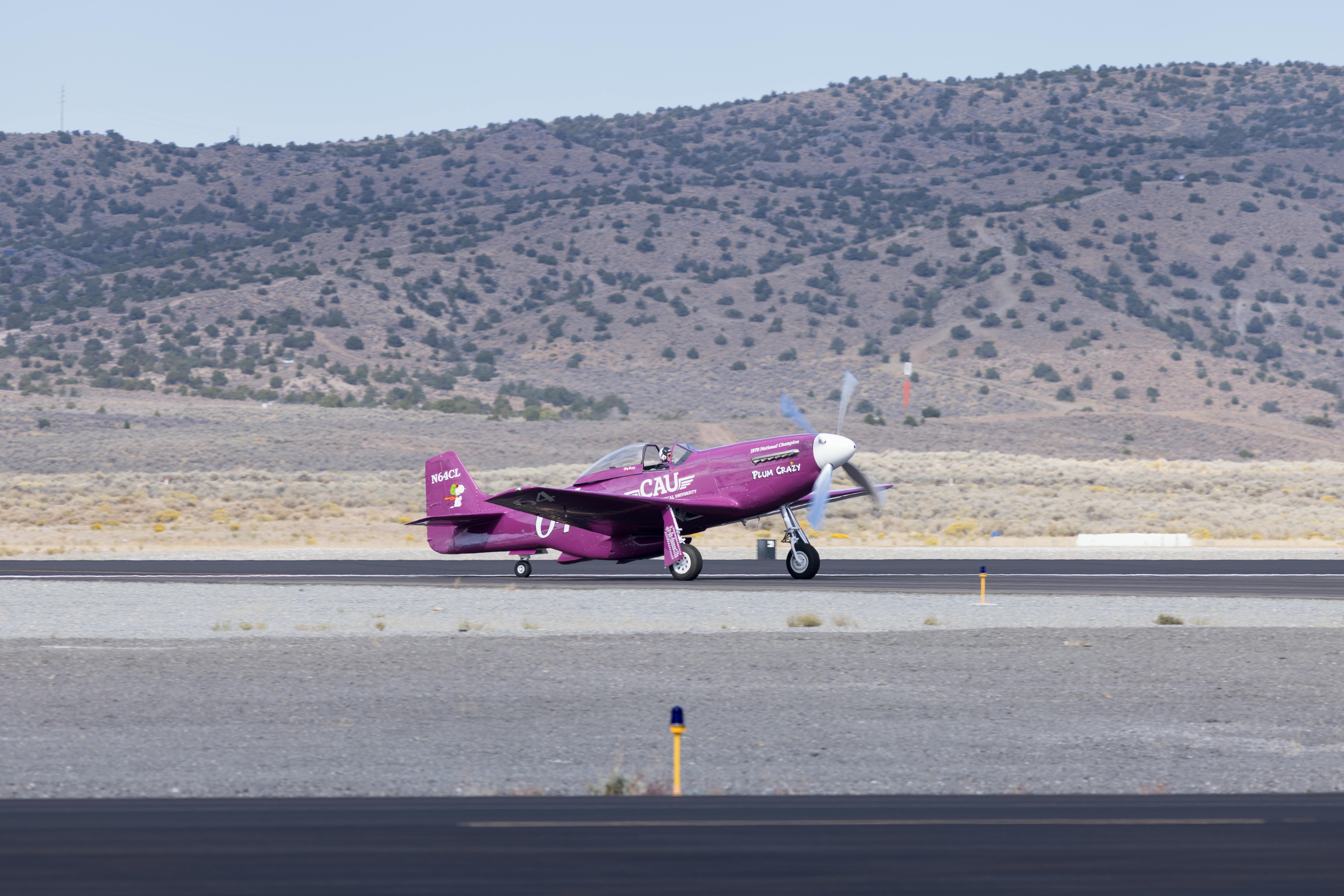 Purple Racing Airplane on Runway in Desert Landscape · Free Stock Photo