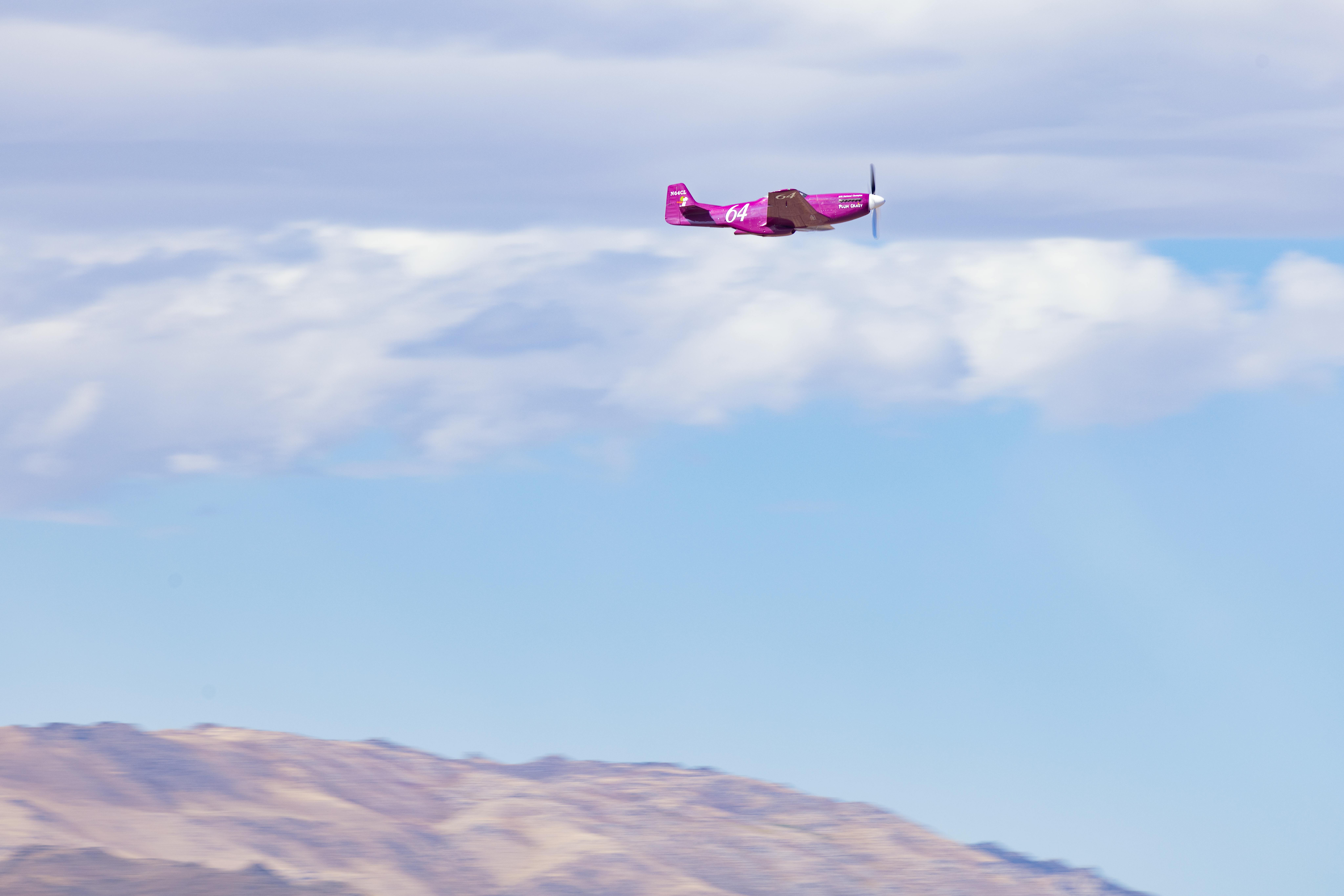 Vibrant Pink Aircraft Against Scenic Sky · Free Stock Photo