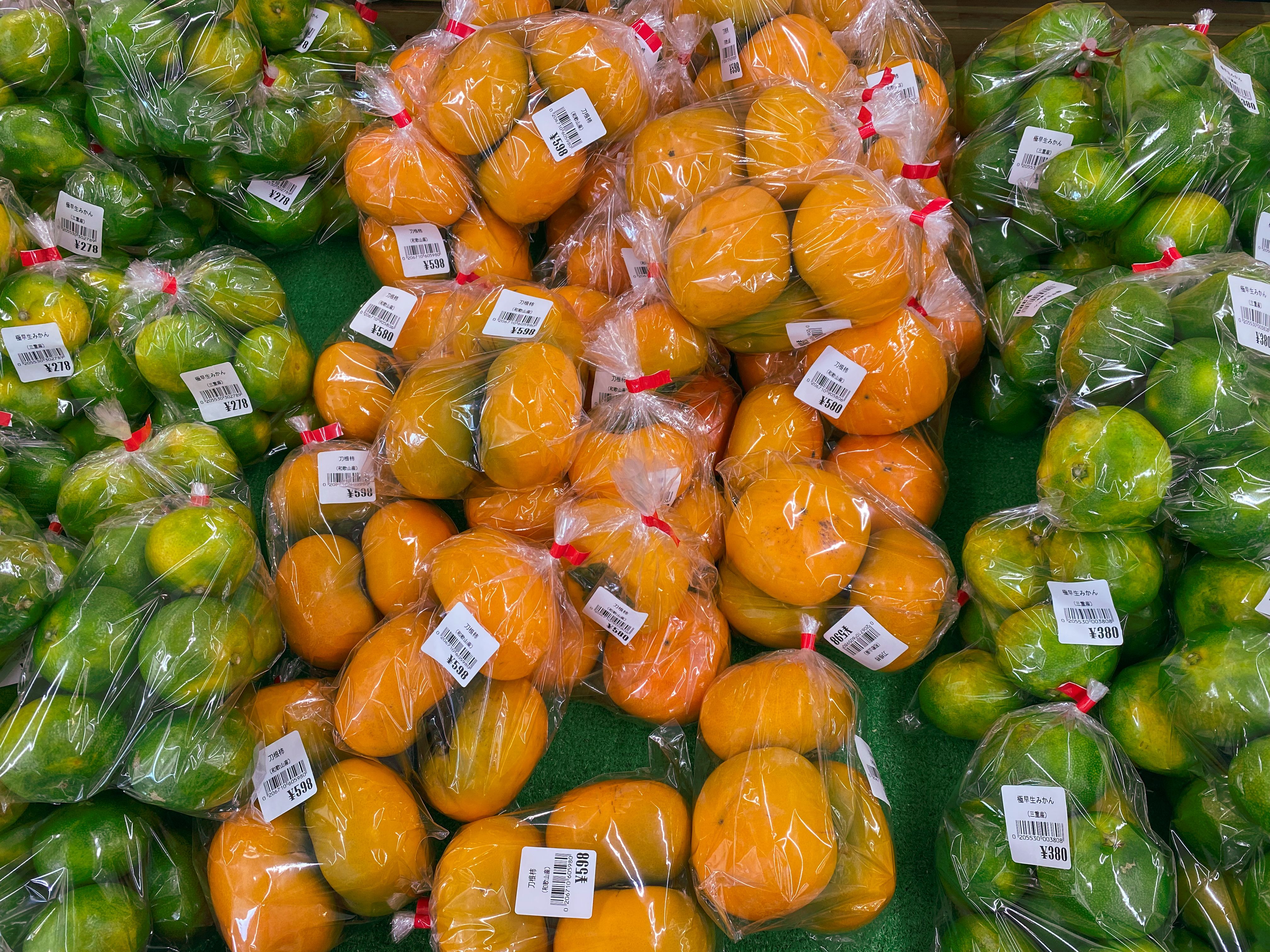 Colorful Persimmons and Citrus Display in Aichi Market · Free Stock Photo