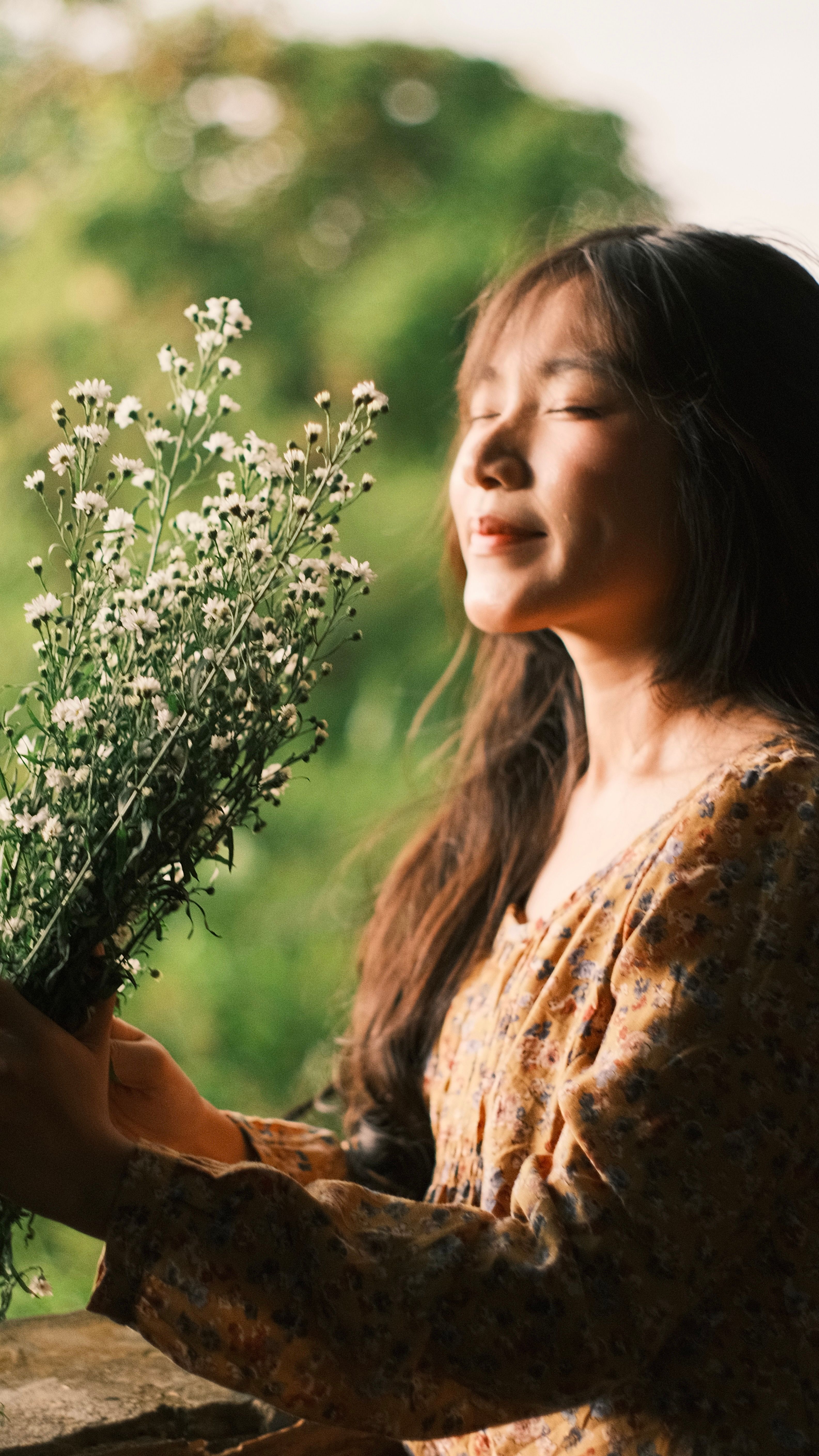 Woman holding flower in hand in nature · Free Stock Photo