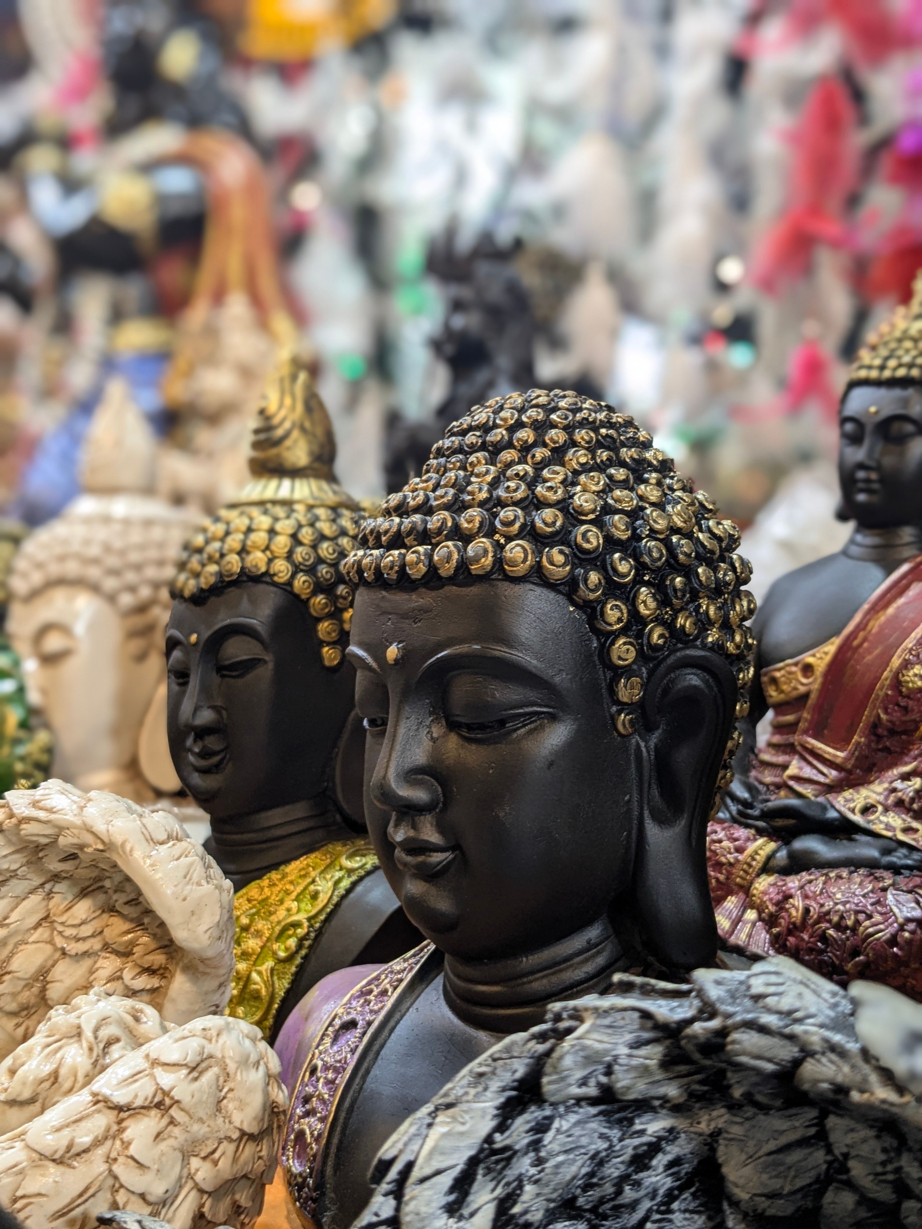 Diverse Buddha Statues in a Vibrant Display · Free Stock Photo