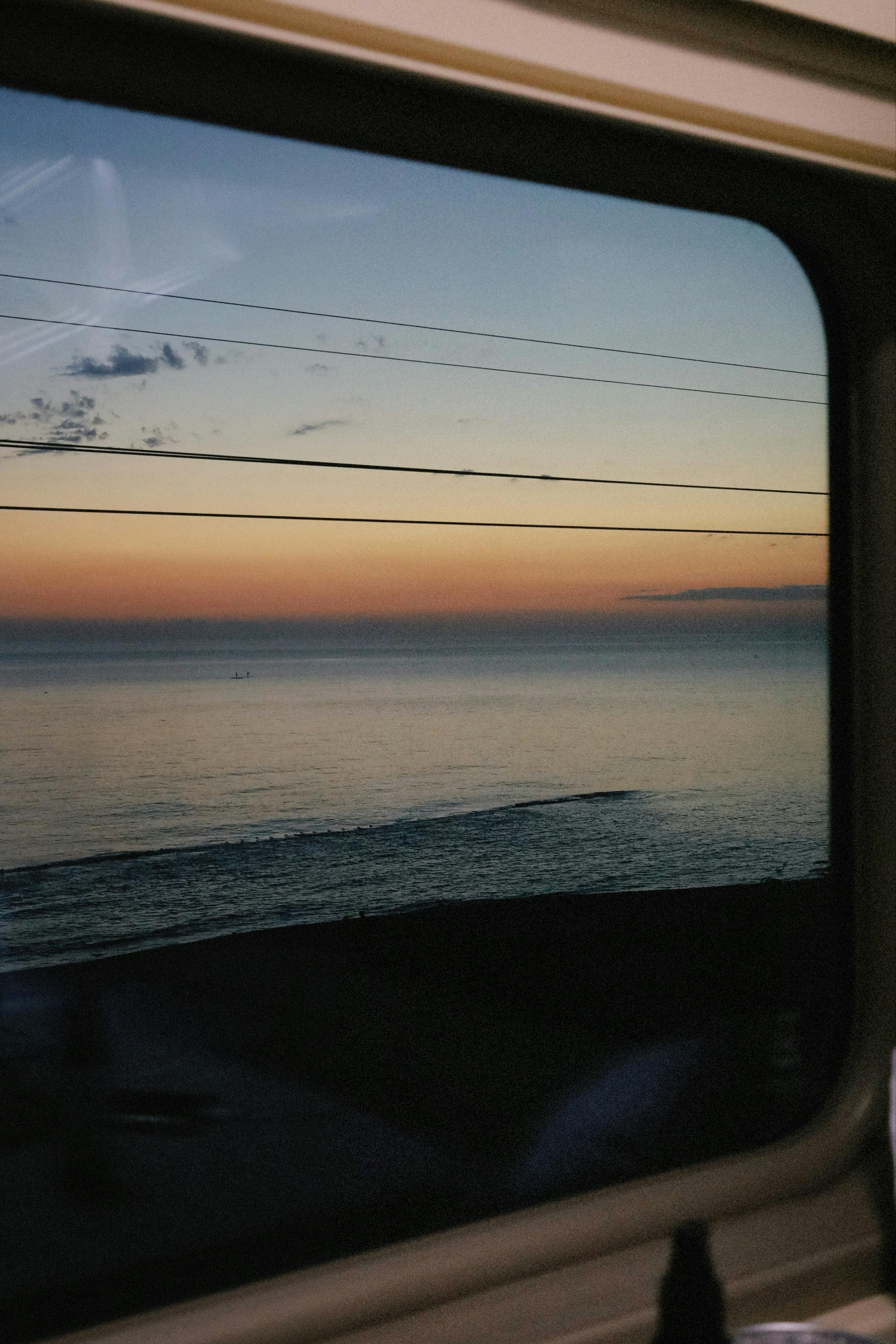 Scenic Coastal Sunset View from Train Window · Free Stock Photo