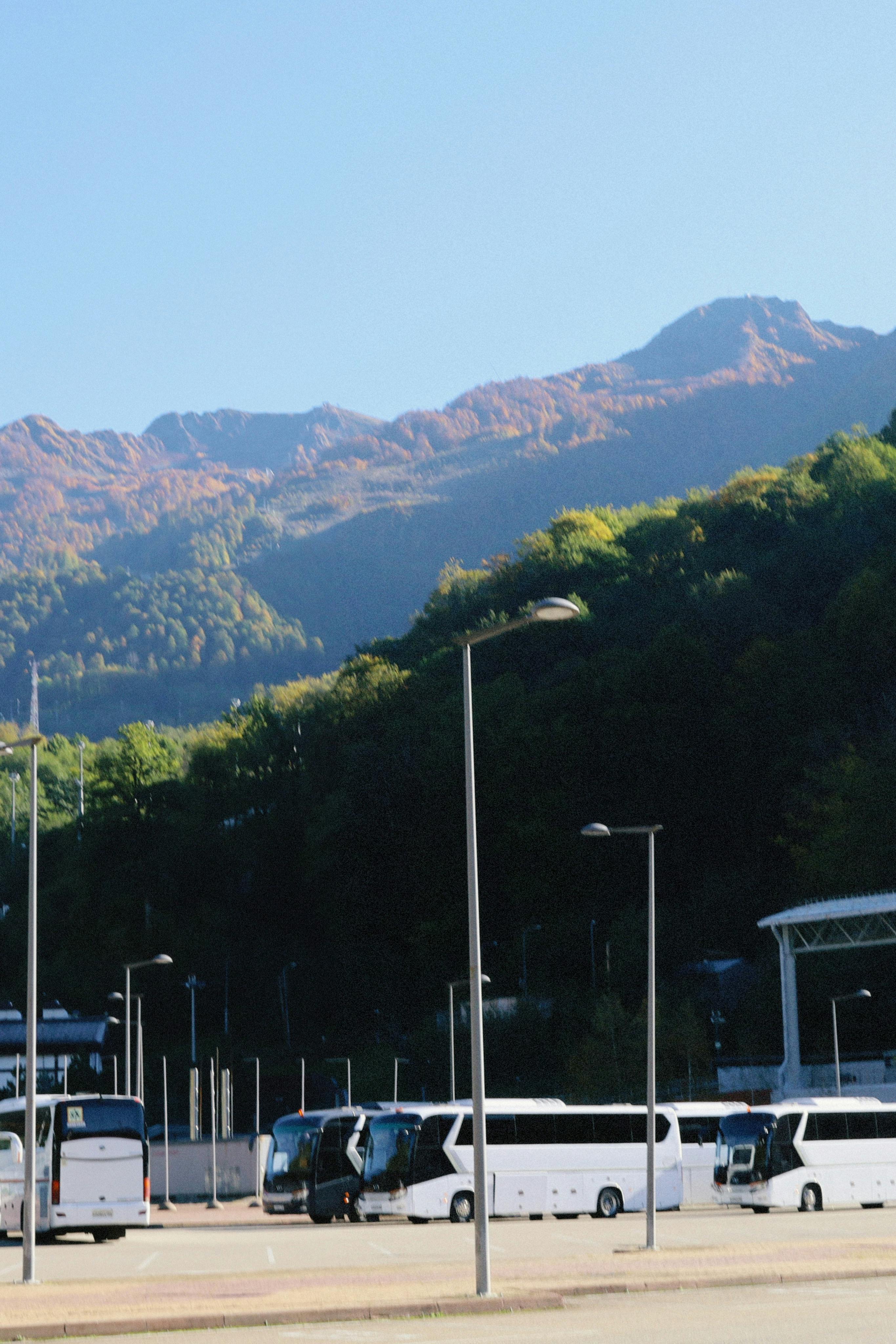 Scenic Mountain View with Parked Tourist Buses · Free Stock Photo