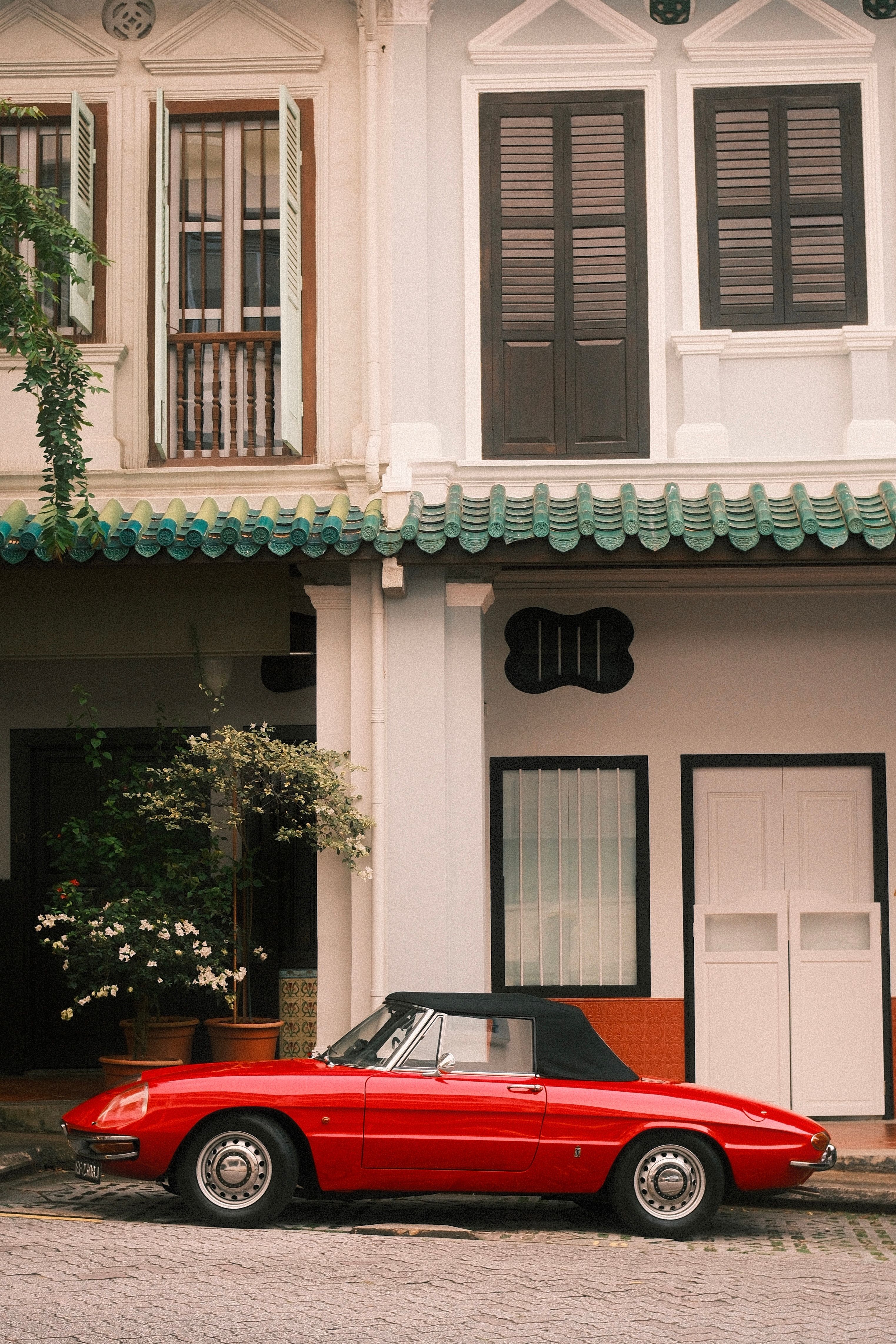 Classic Red Convertible Parked by Heritage Building · Free Stock Photo