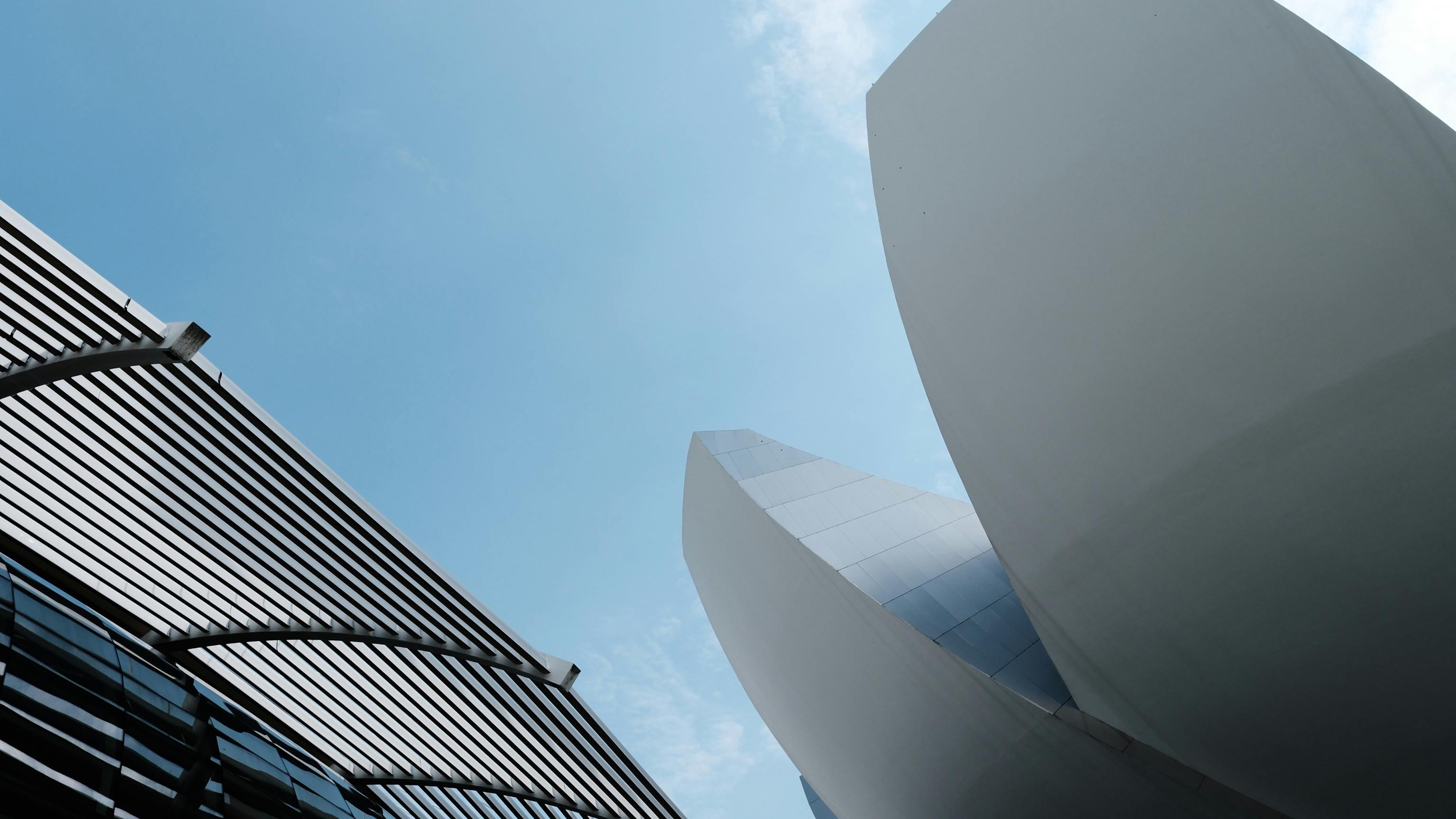 Modern architectural structures against blue sky · Free Stock Photo