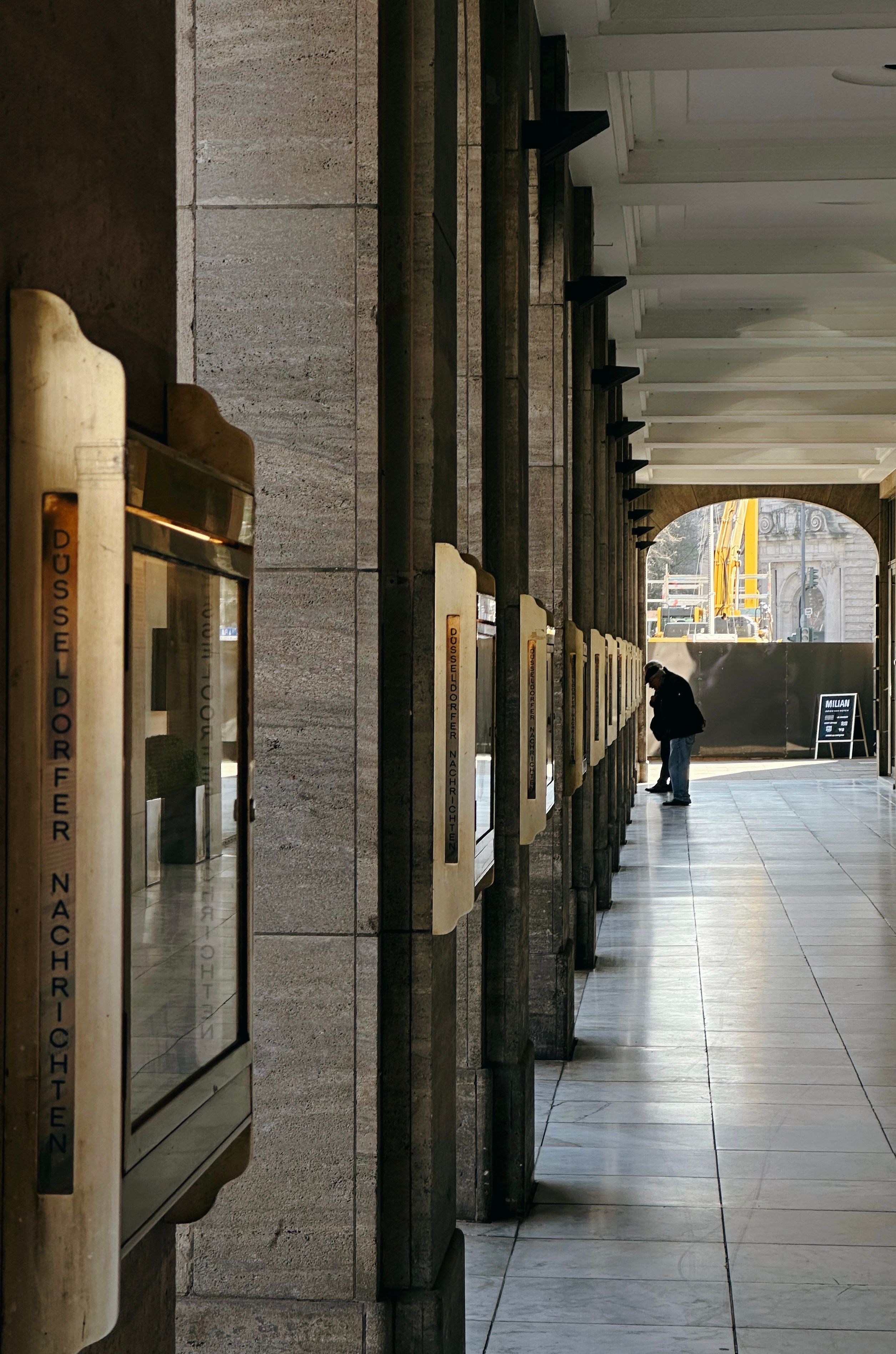 Urban Archway Corridor with Vintage Display Boards · Free Stock Photo