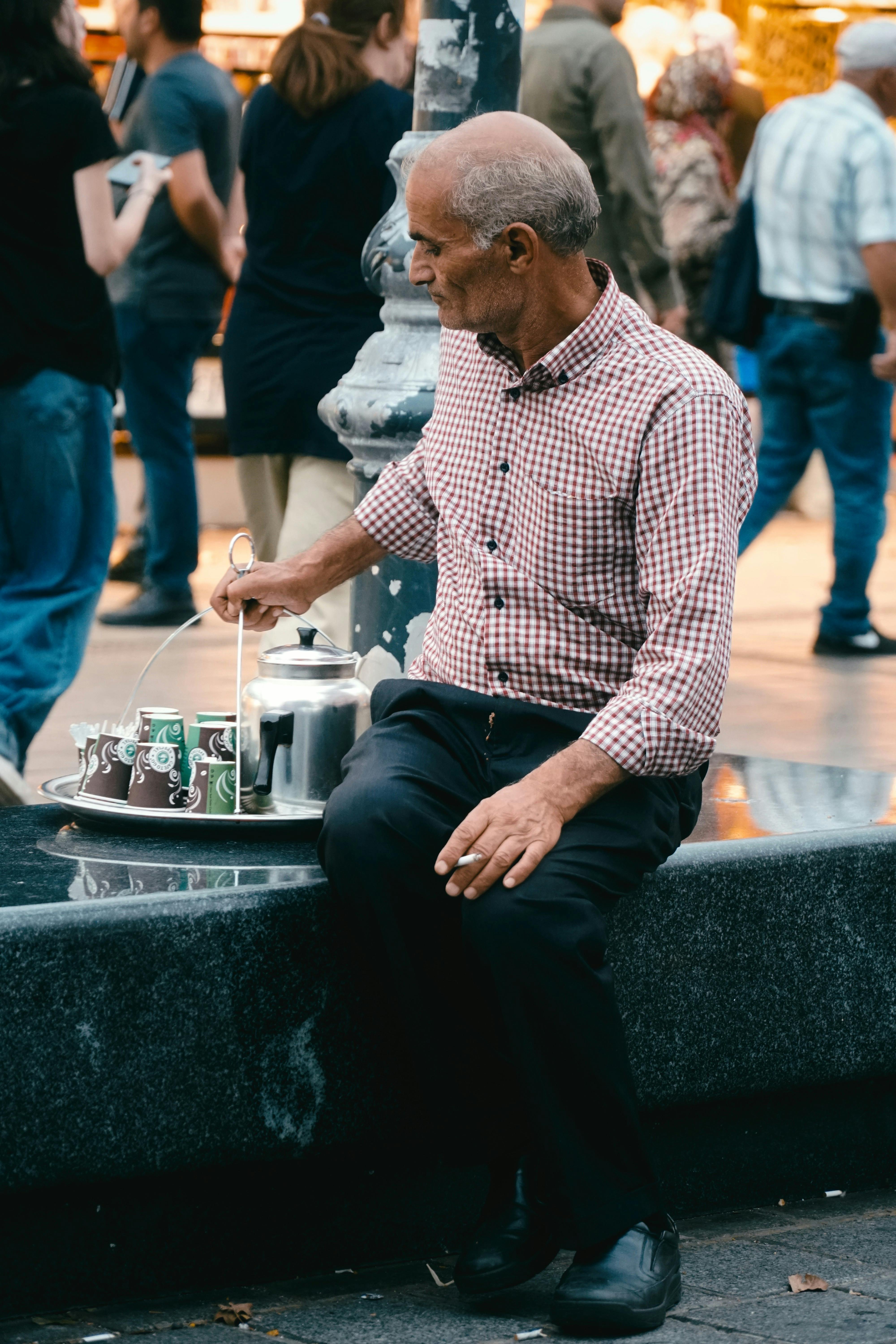 Street Vendor Serving Traditional Turkish Tea · Free Stock Photo