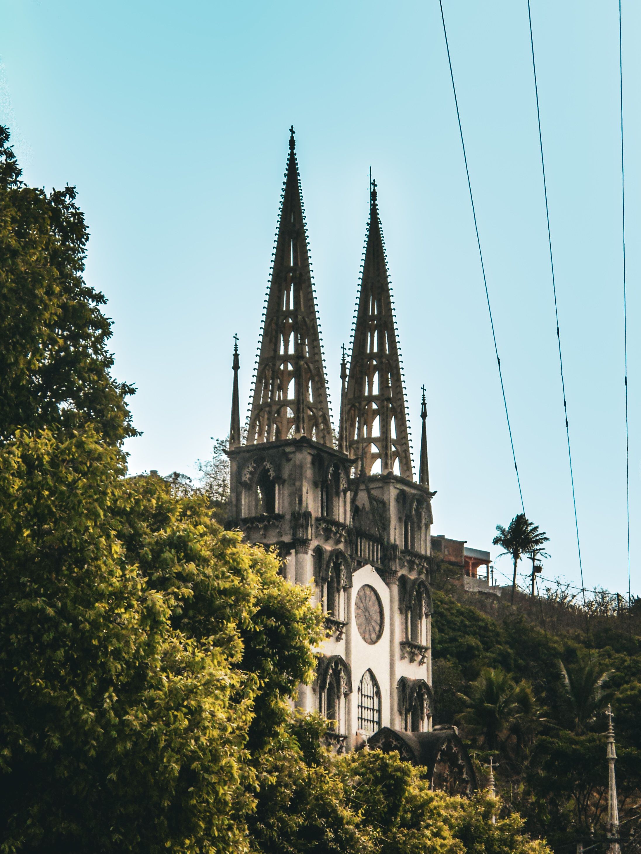 Gothic Church Spires Amidst Verdant Foliage · Free Stock Photo