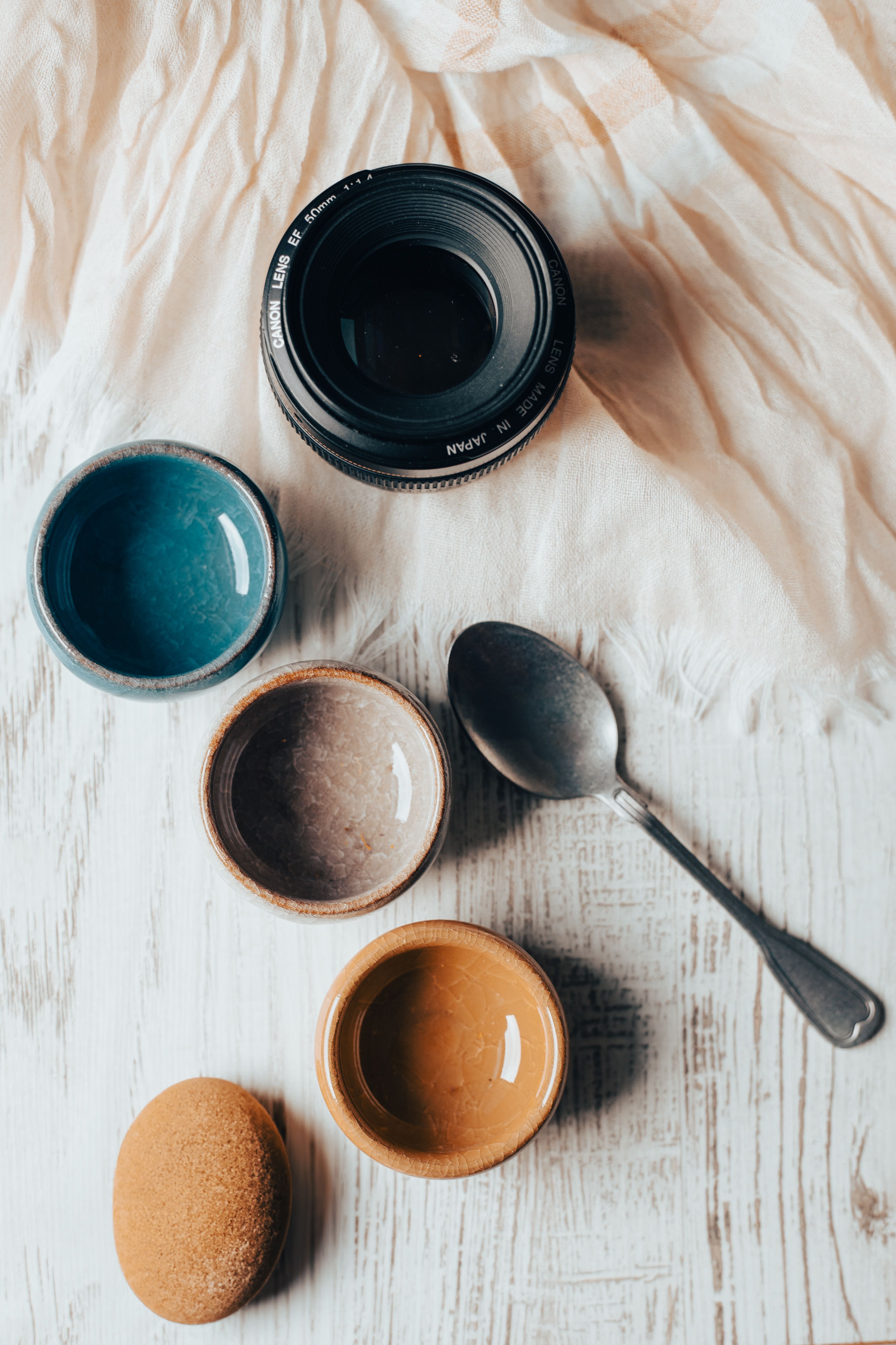 Artistic Flat Lay with Camera Lens and Pottery · Free Stock Photo