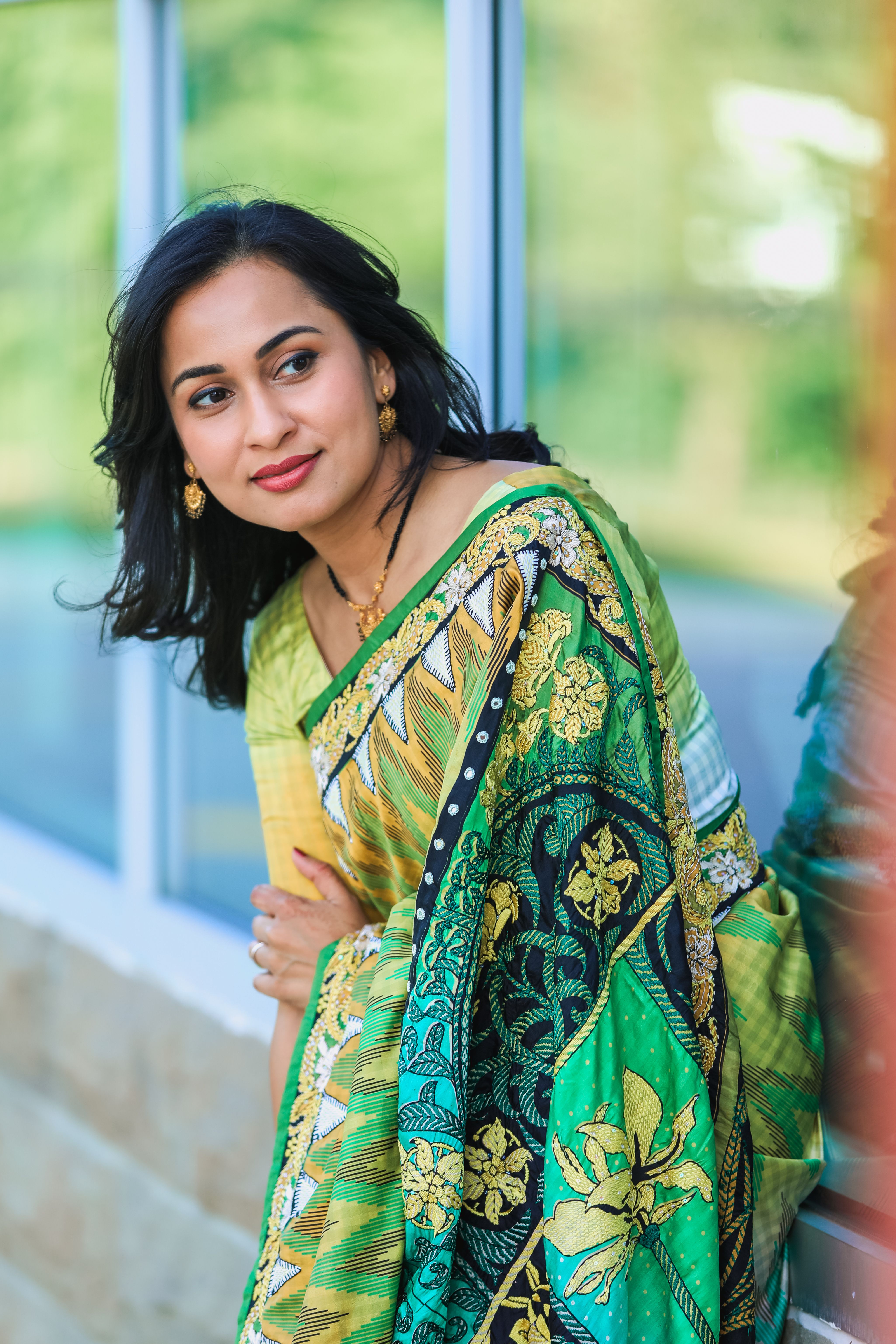 Woman in Traditional Green Sari Near Window · Free Stock Photo
