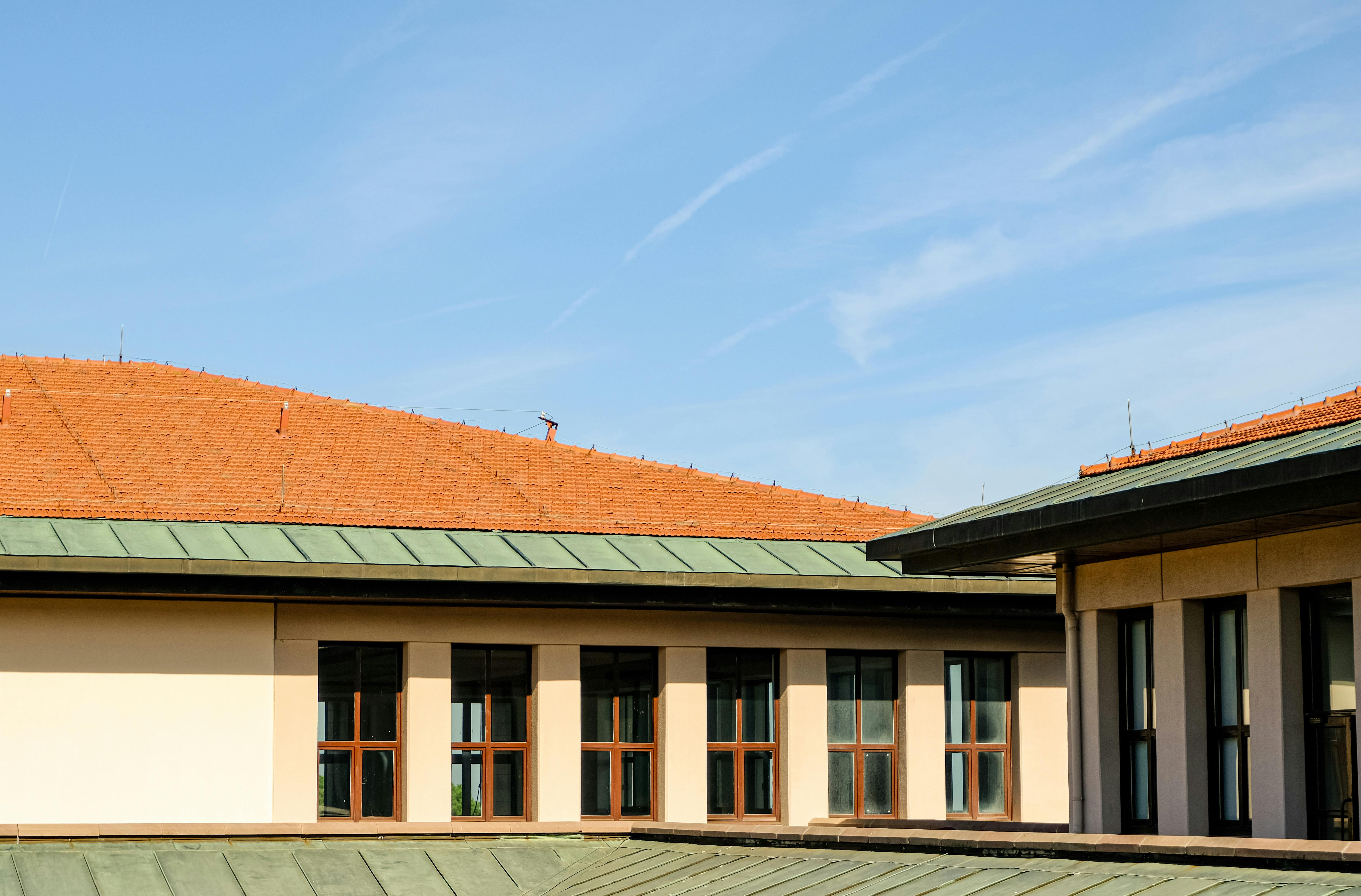 Modern Building Roofline with Clear Blue Sky · Free Stock Photo