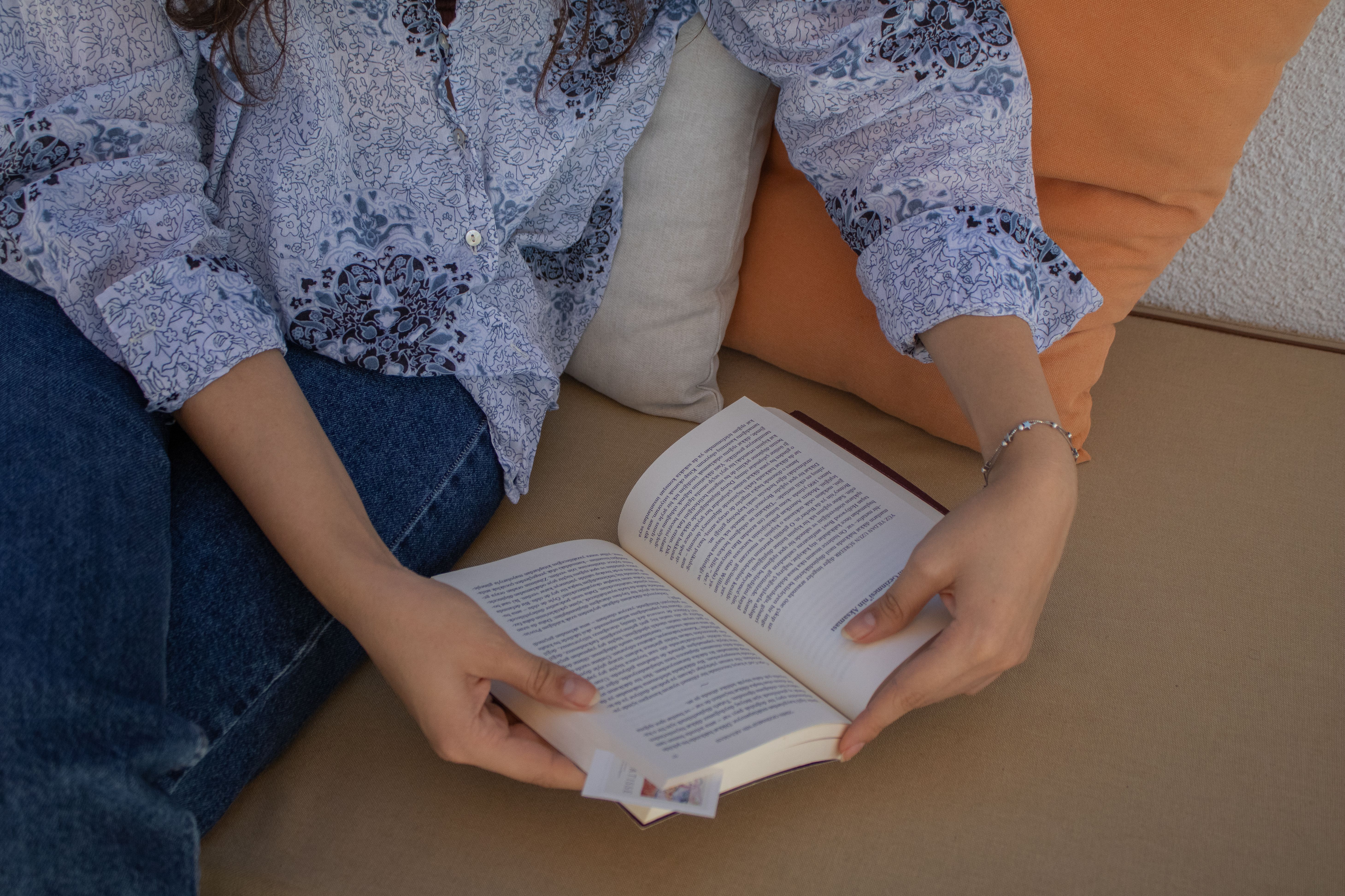 Person Relaxing with a Book in a Cozy Setting · Free Stock Photo