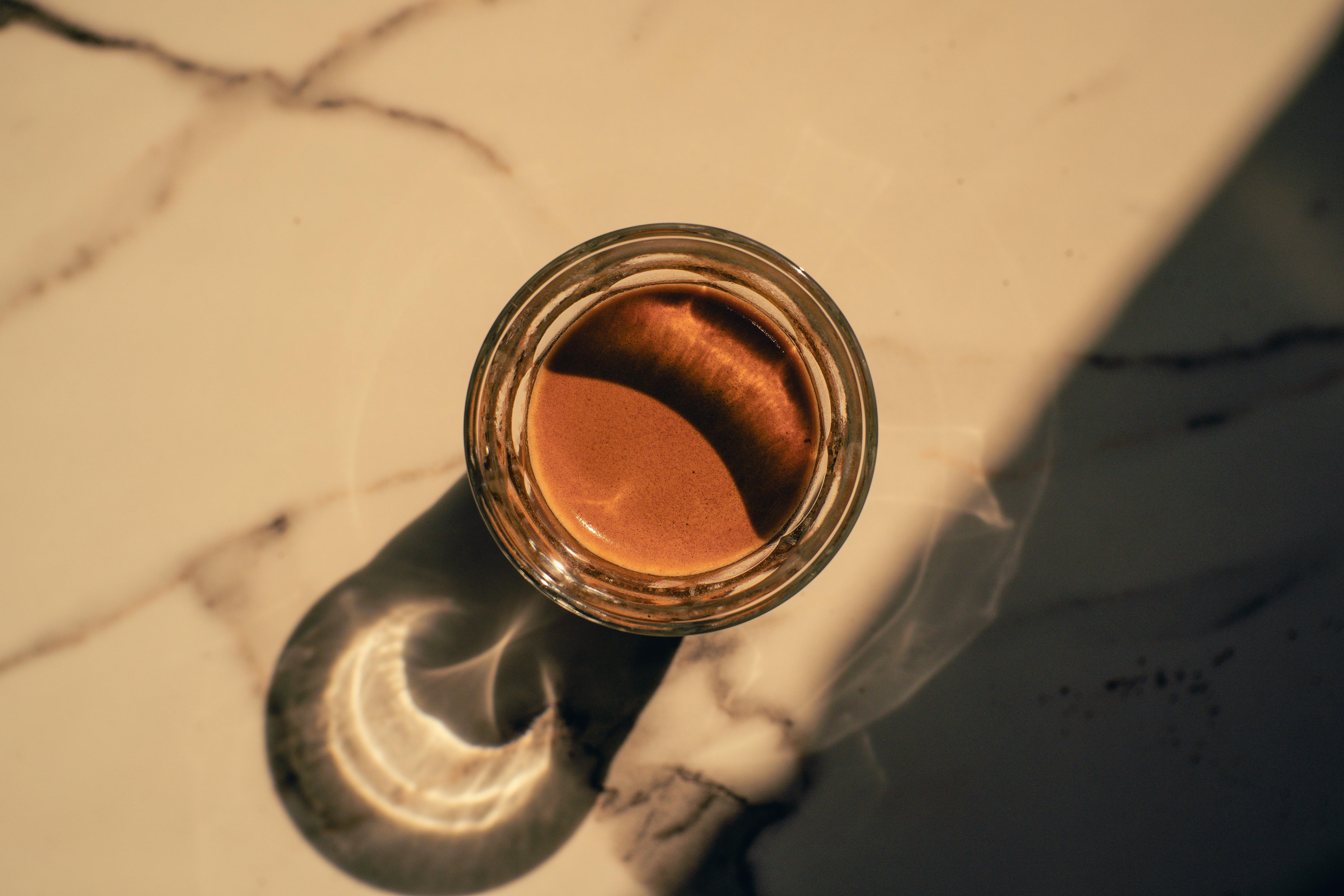 Espresso Shot with Golden Sunlight Reflection · Free Stock Photo