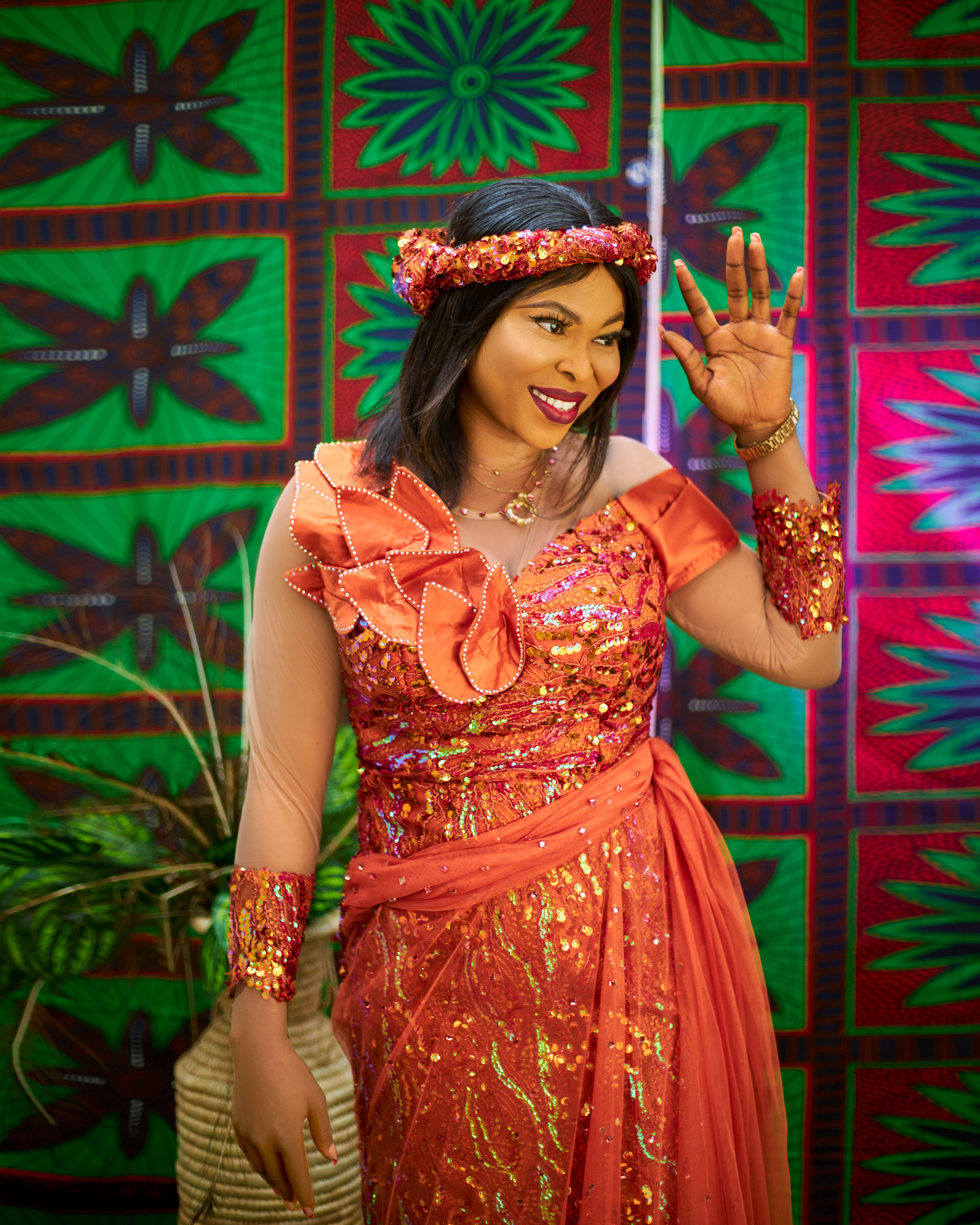 Elegant Woman in Traditional Orange Dress · Free Stock Photo