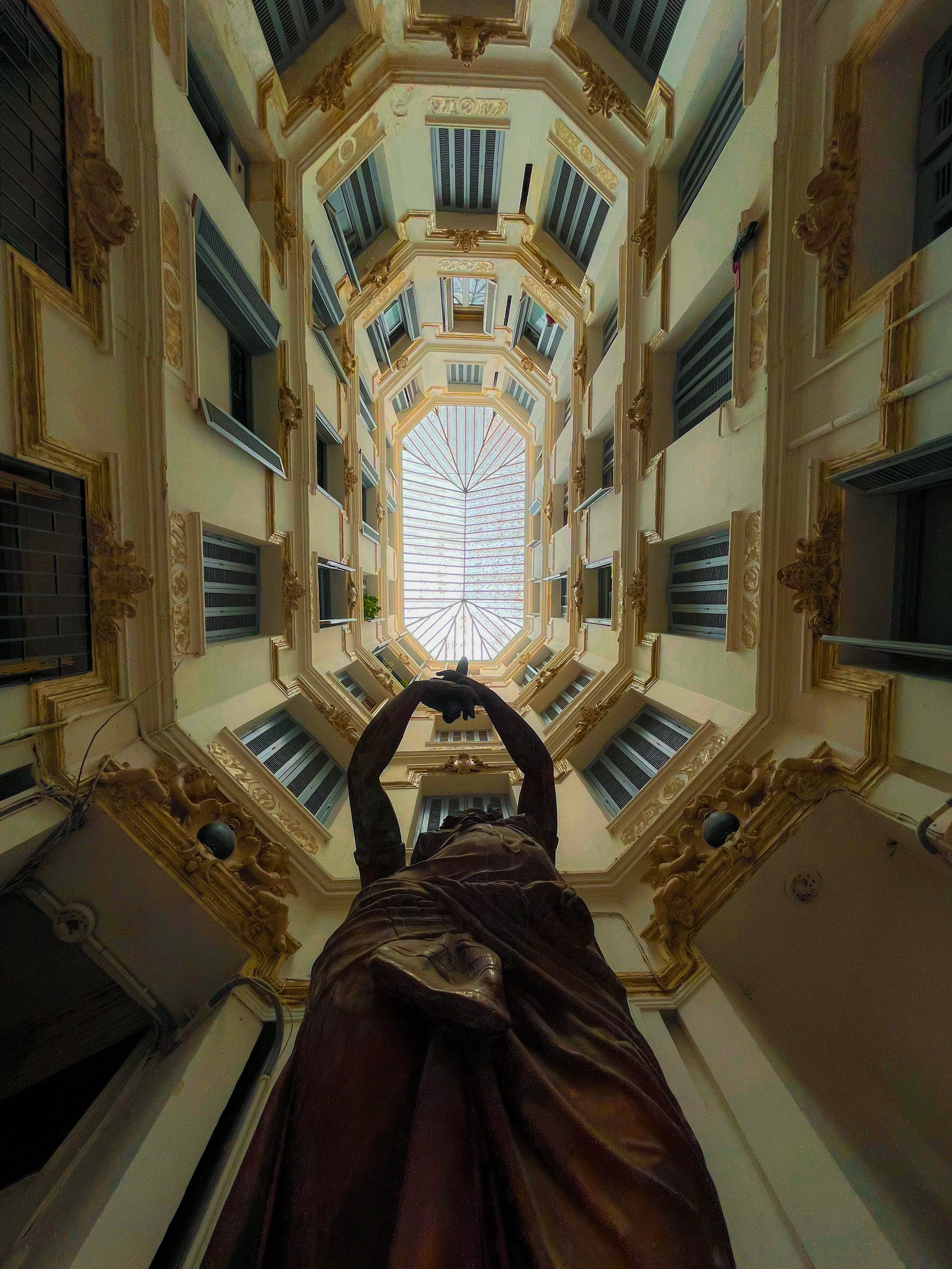 Elegant atrium view with architectural statue · Free Stock Photo