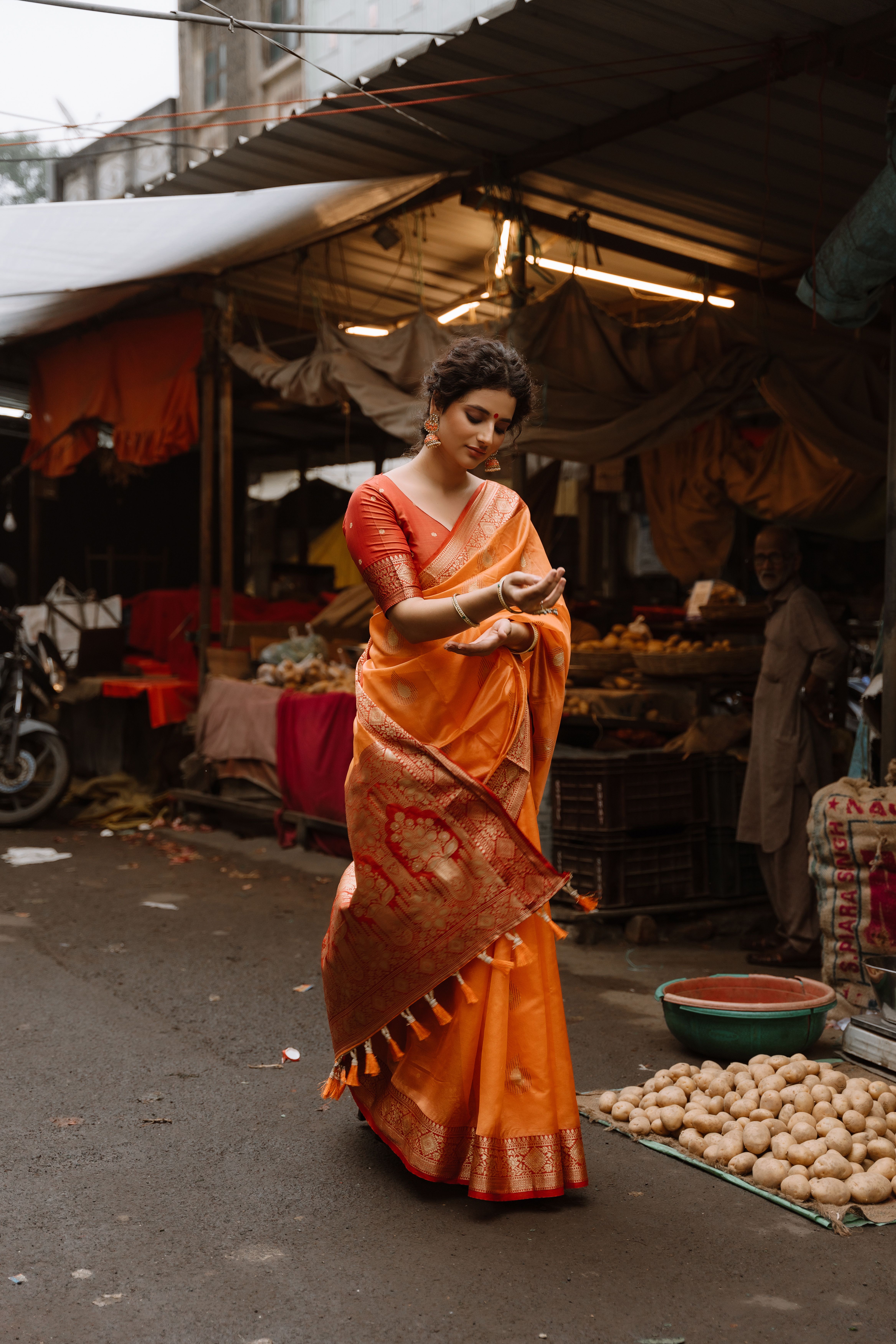Elegant Woman in Orange Saree at Local Market · Free Stock Photo