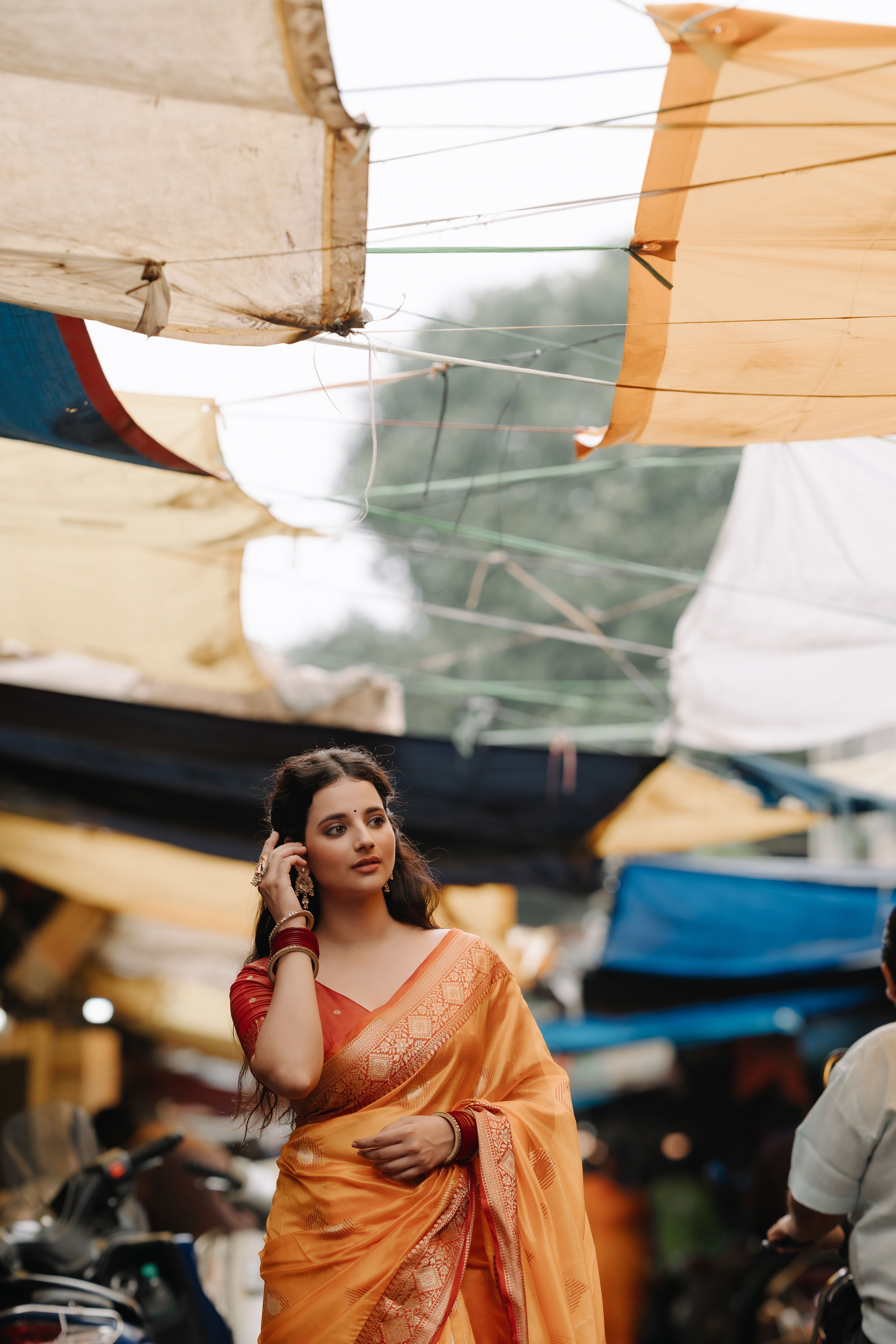 Woman in Traditional Sari Walking Through Market · Free Stock Photo