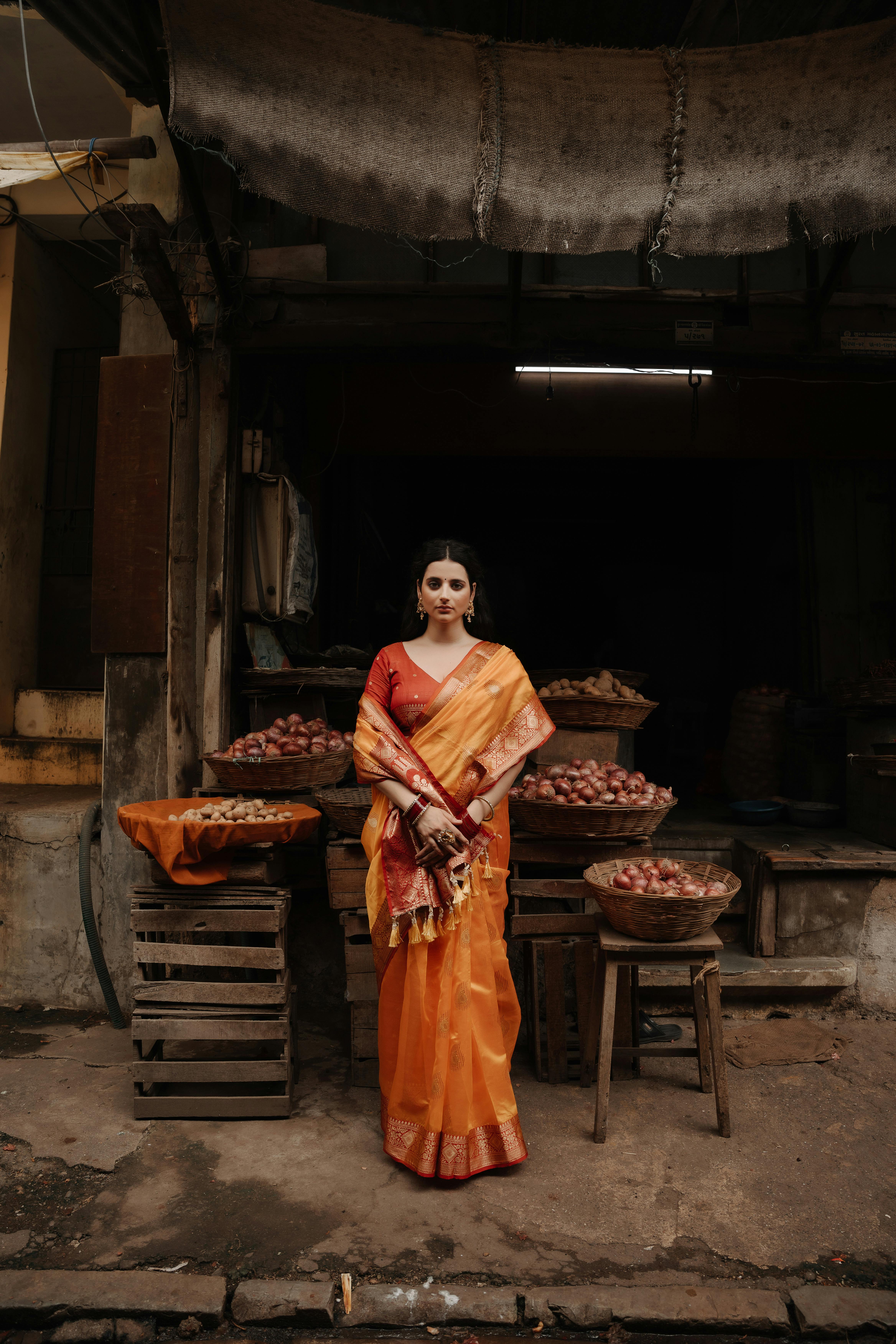 Woman in Traditional Sari at Market Stall · Free Stock Photo