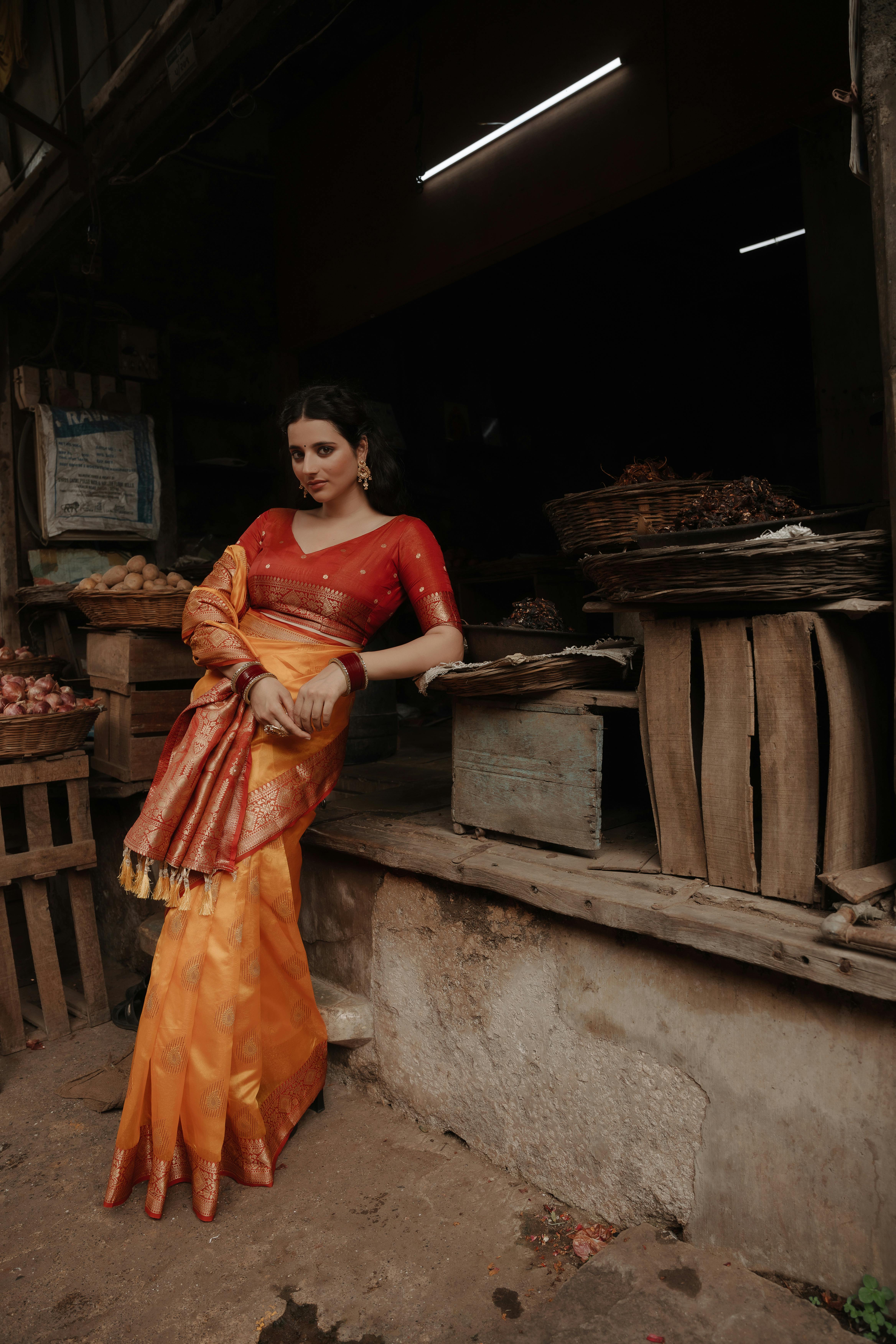 Woman in Traditional Saree at Rustic Market · Free Stock Photo