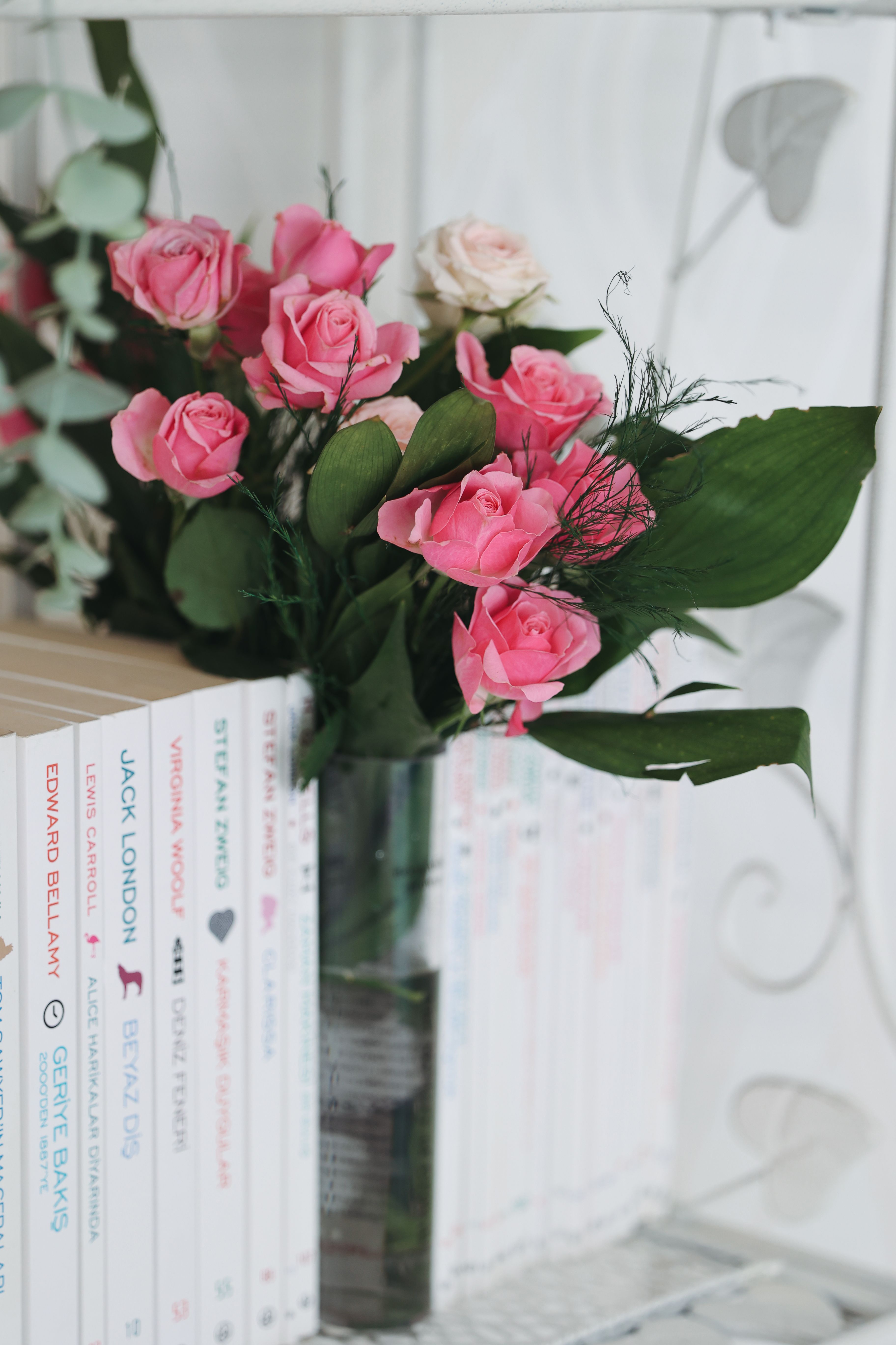 Elegant Bouquet of Pink Roses Beside Classic Books · Free Stock Photo