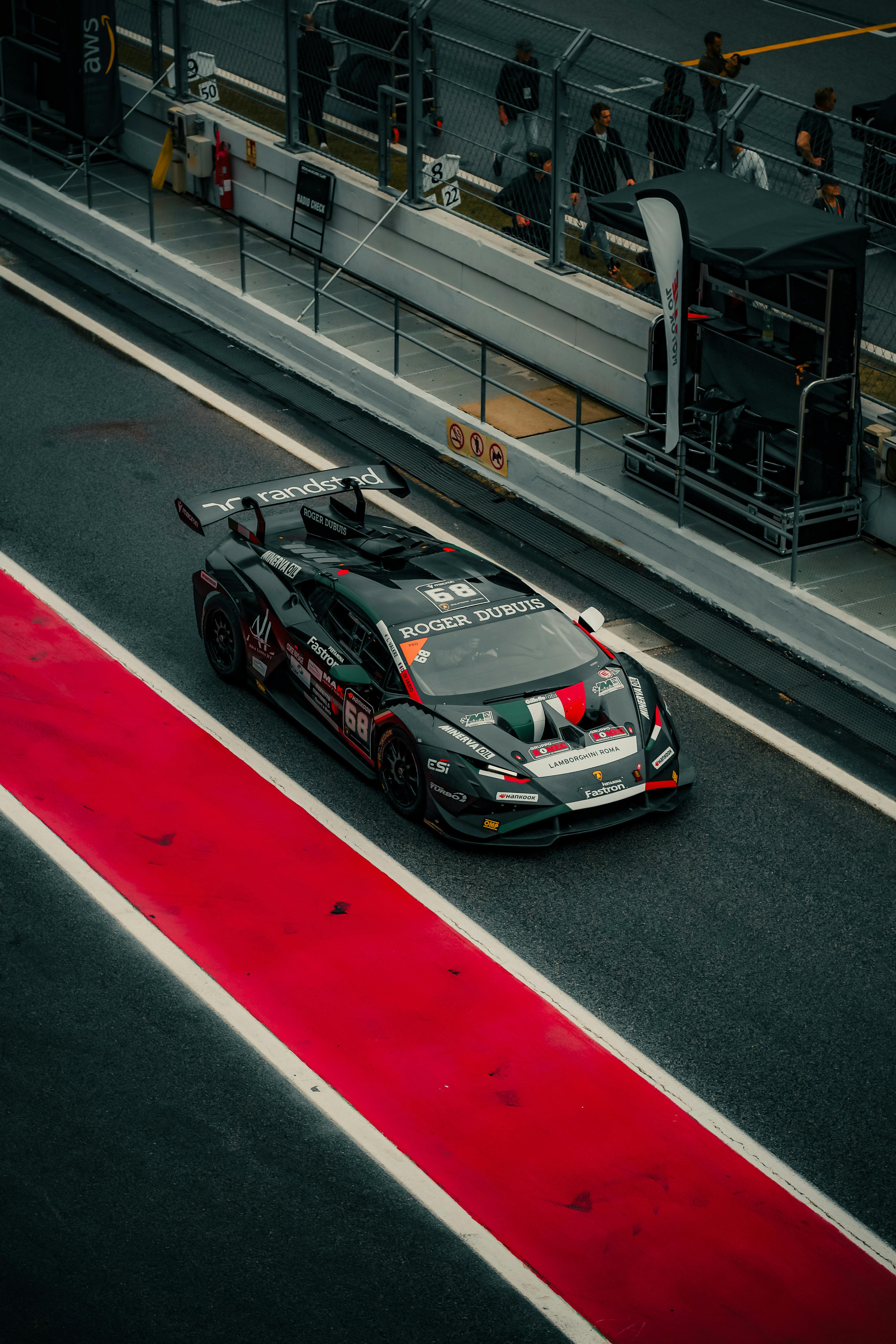 High-Performance Sports Car in Racing Pit Lane · Free Stock Photo