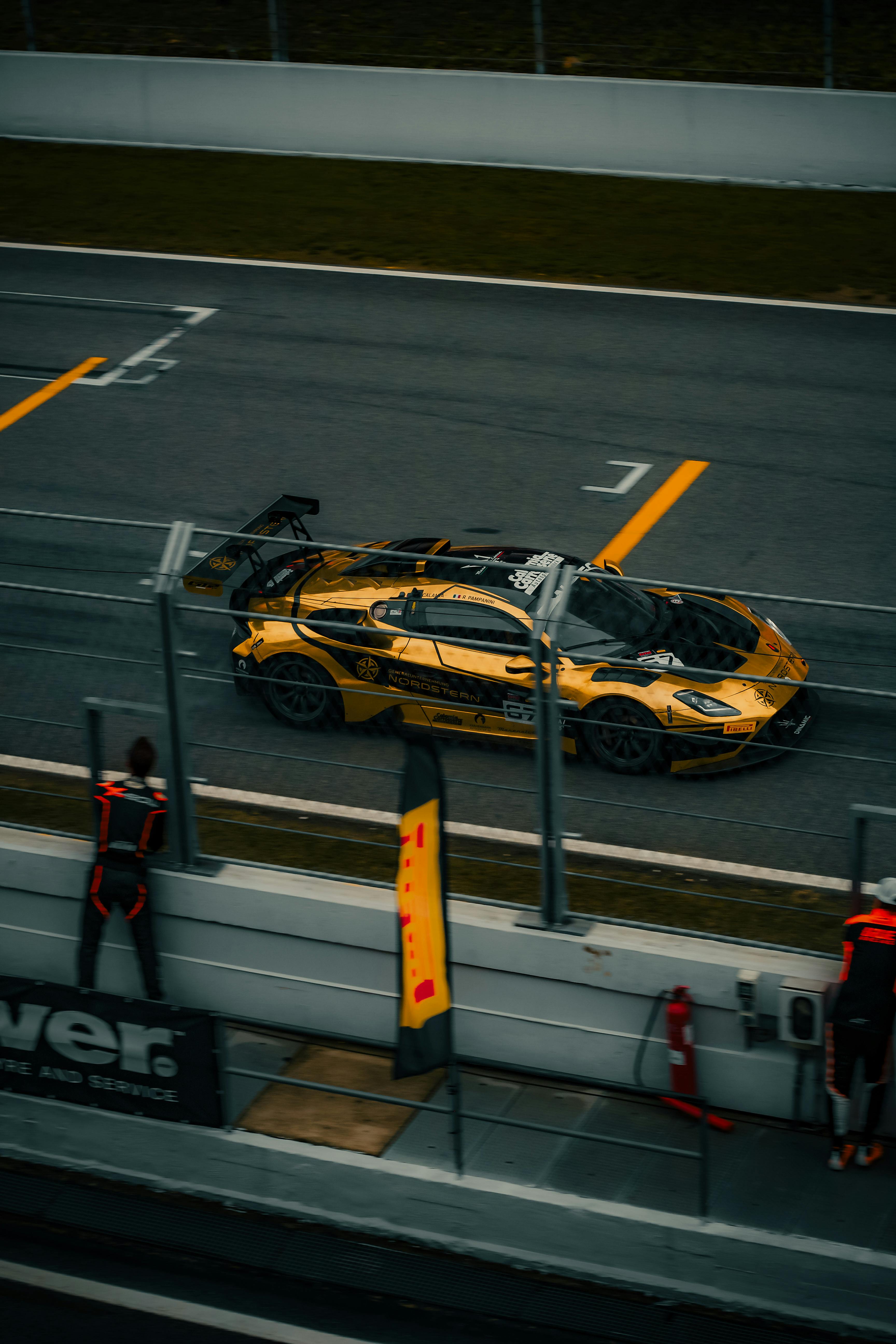 High-Speed Racing Car on Motorsport Track · Free Stock Photo