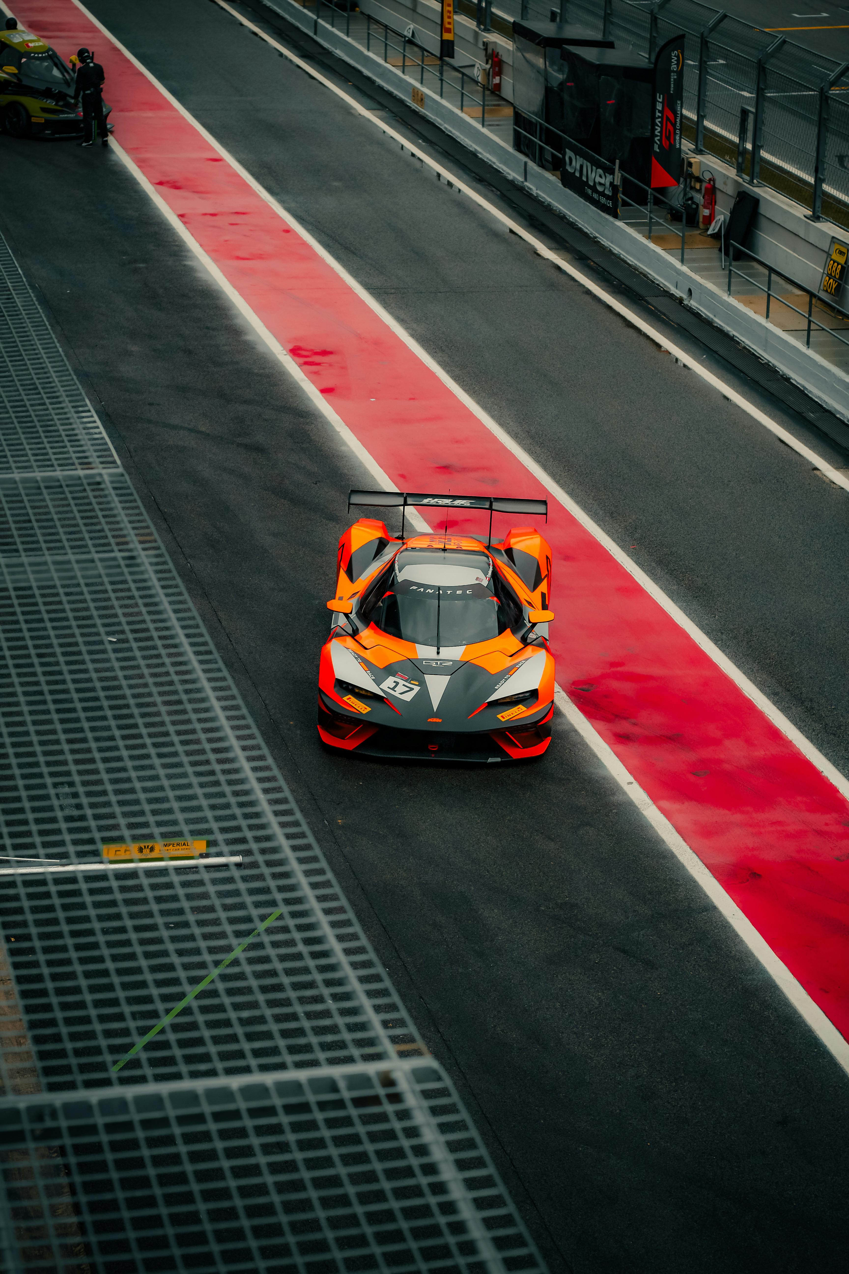 Vibrant Race Car in Pit Lane from Above · Free Stock Photo