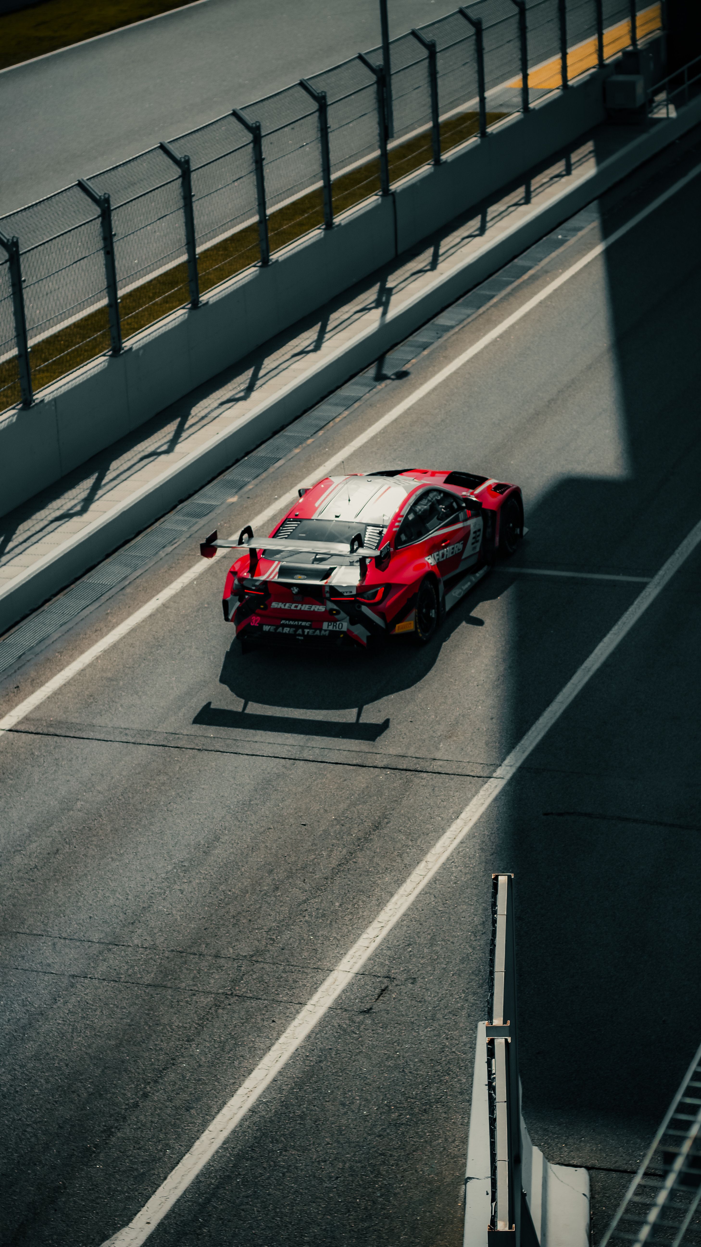 High-Speed Red Sports Car on Race Track · Free Stock Photo