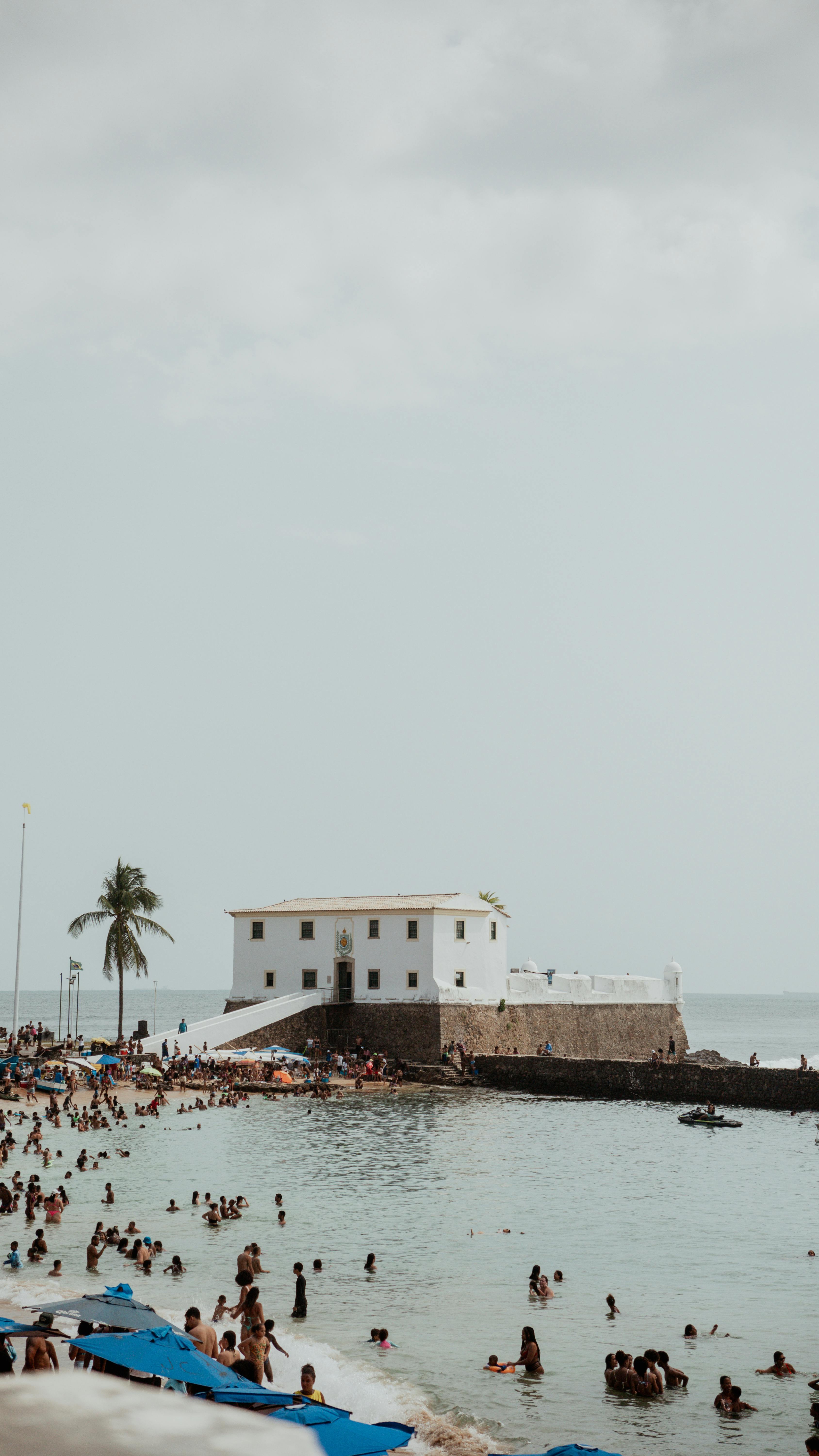 Historic Beachfront Building with Crowd Scenery · Free Stock Photo