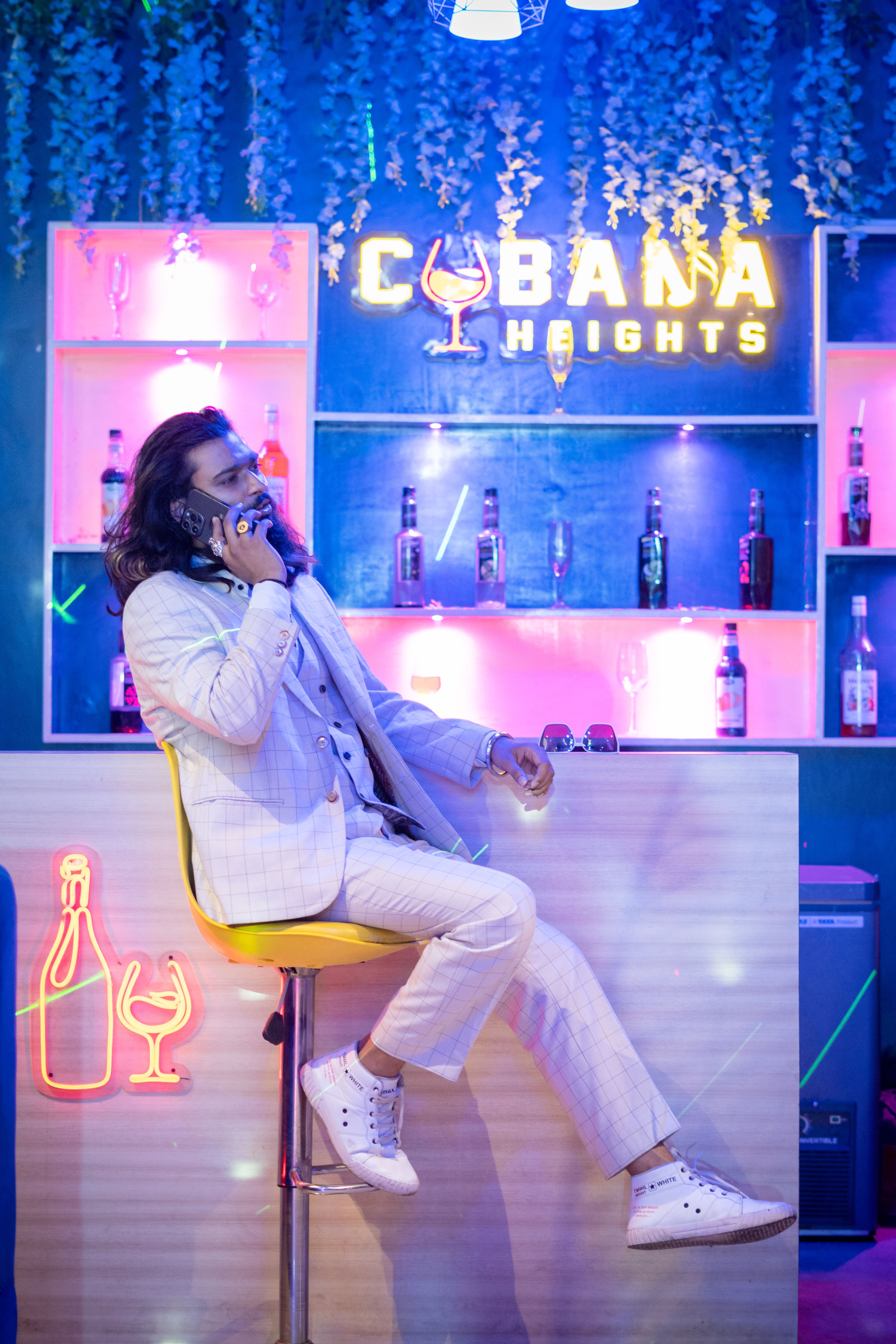 Stylish Man Relaxing in Vibrant Nightclub Setting · Free Stock Photo