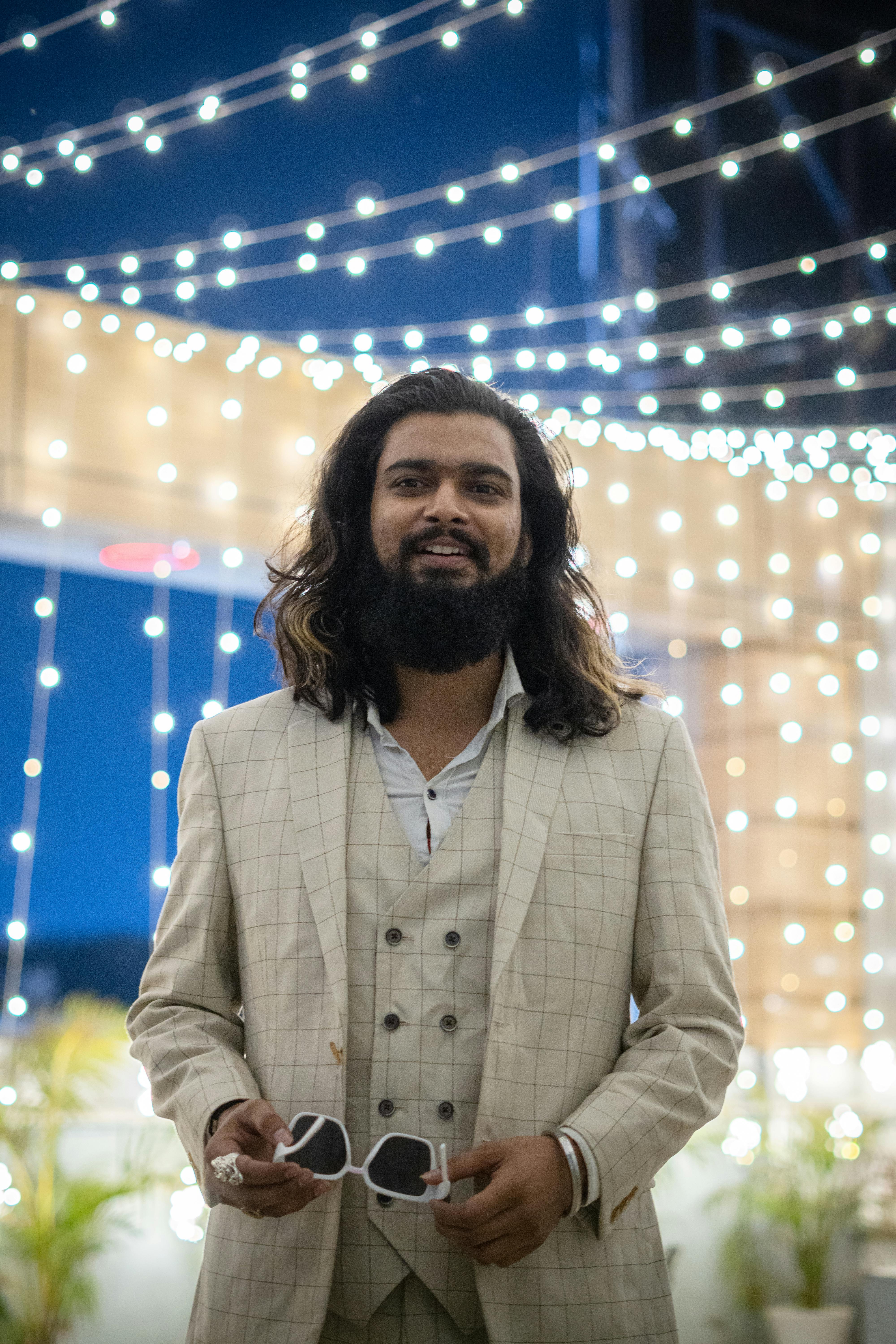 Stylish Man at Night Party with Festive Lights · Free Stock Photo