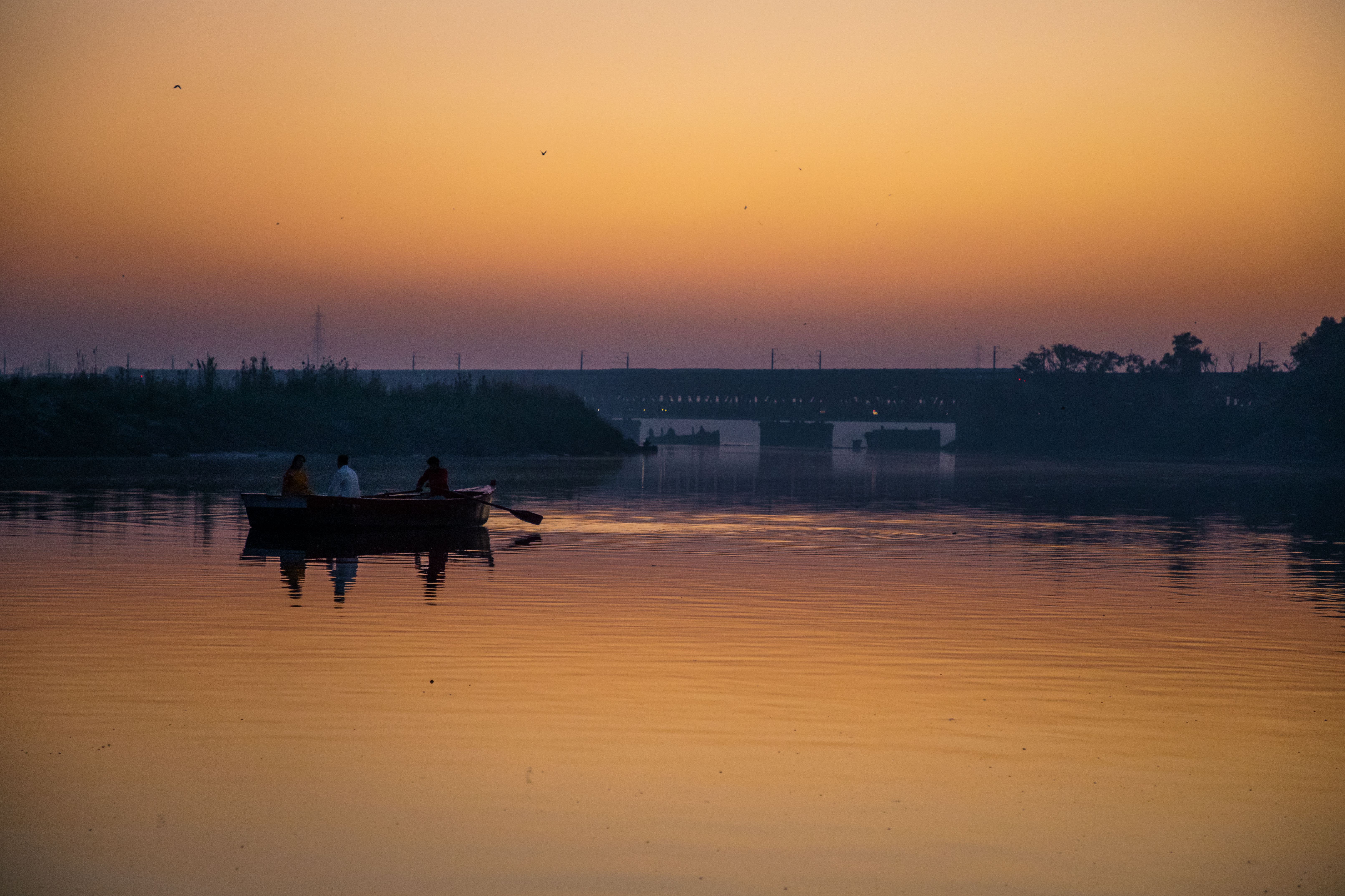 Serene Sunset Boat Ride on Calm River · Free Stock Photo