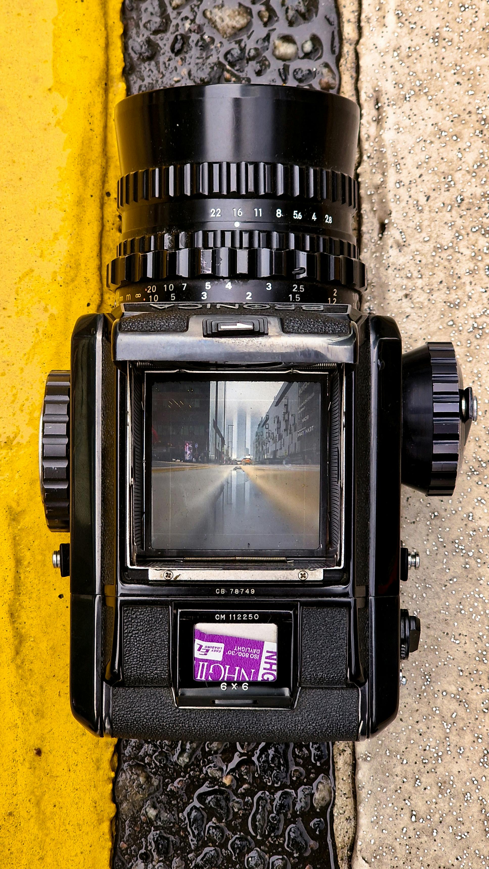 Vintage Camera with Reflection of Urban Street · Free Stock Photo