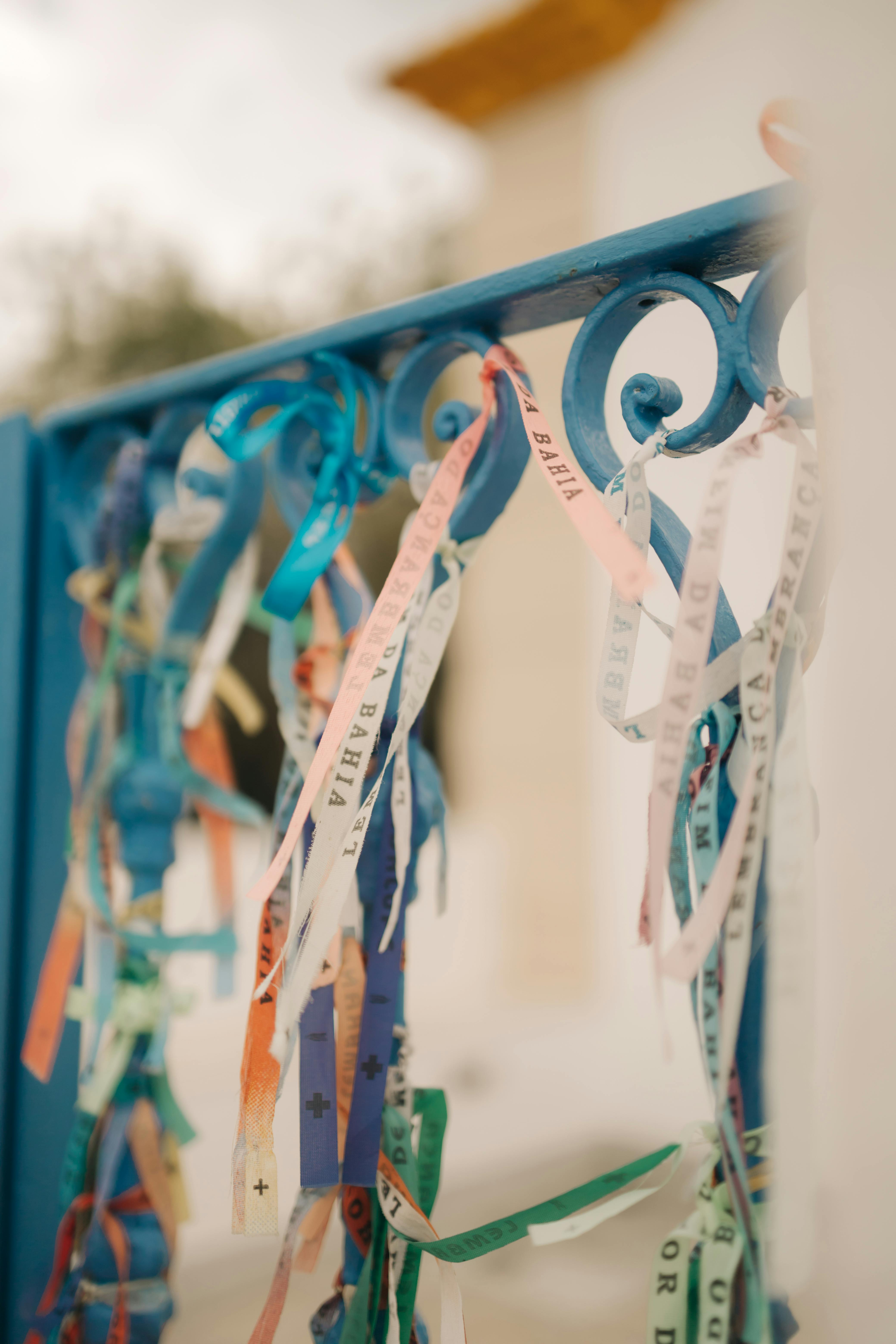 Colorful Ribbons on Blue Wrought Iron Gate · Free Stock Photo