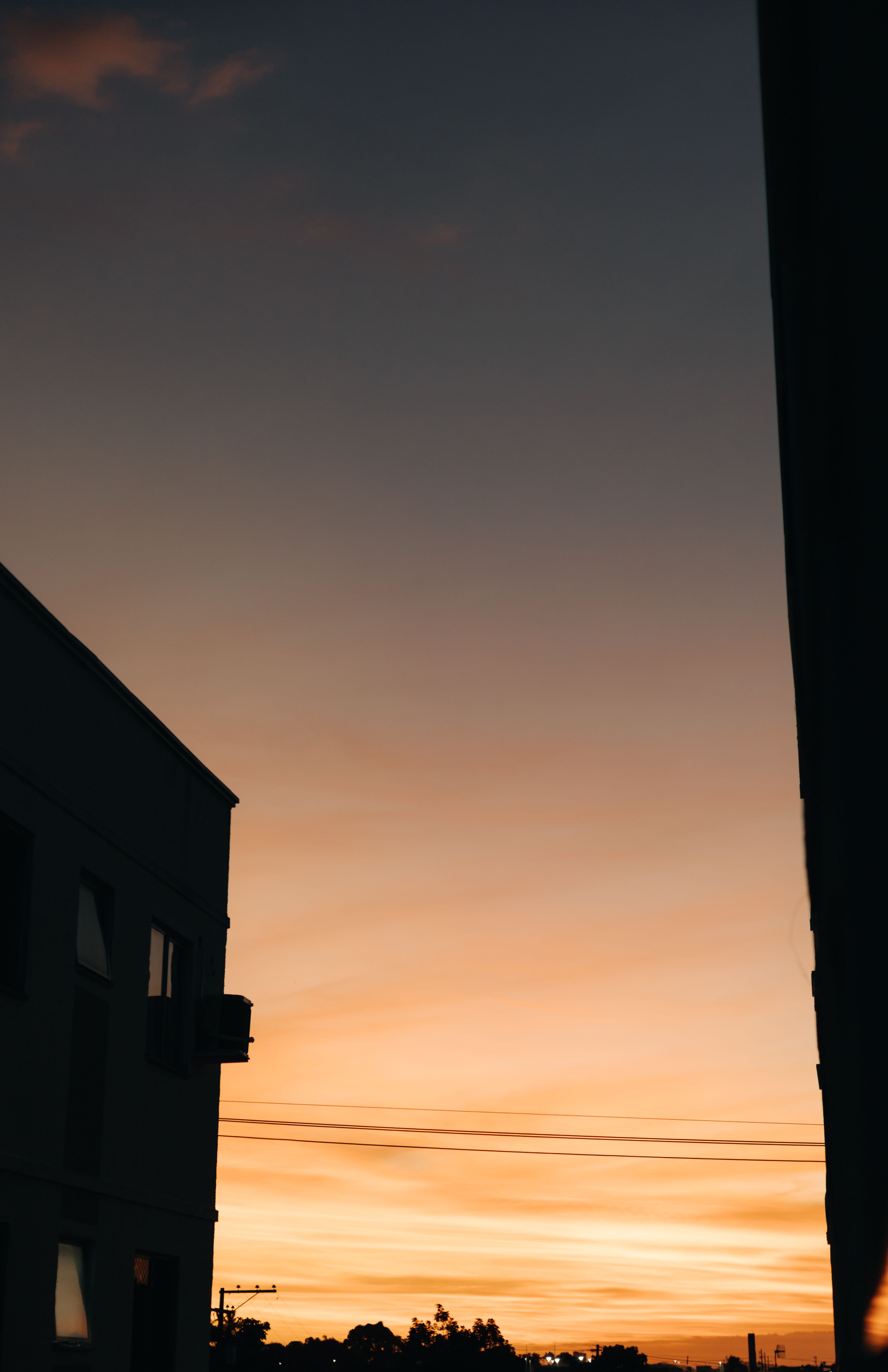 Serene Urban Sunset with Silhouetted Buildings · Free Stock Photo