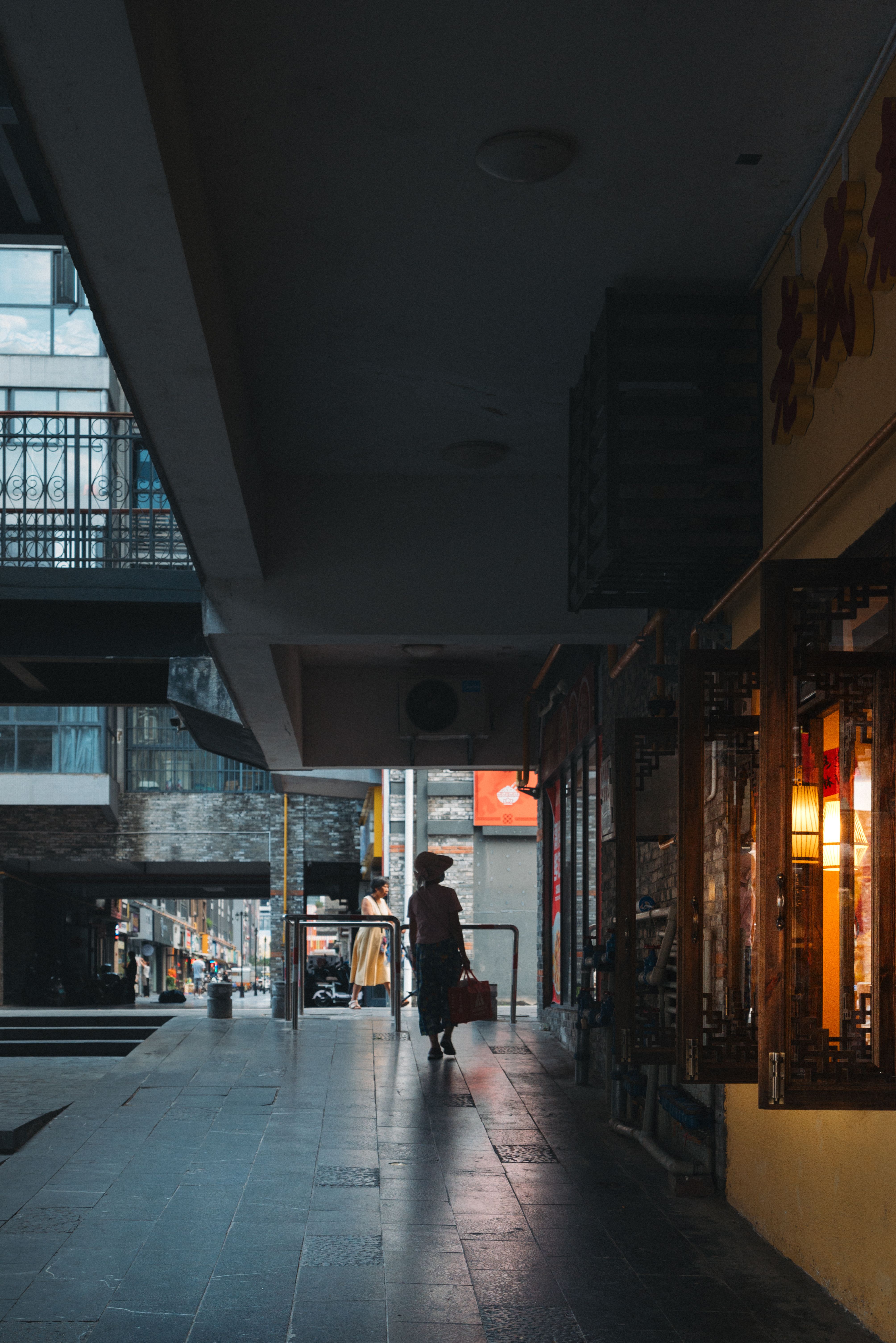 Silhouette of a Person Walking in Urban Alleyway · Free Stock Photo