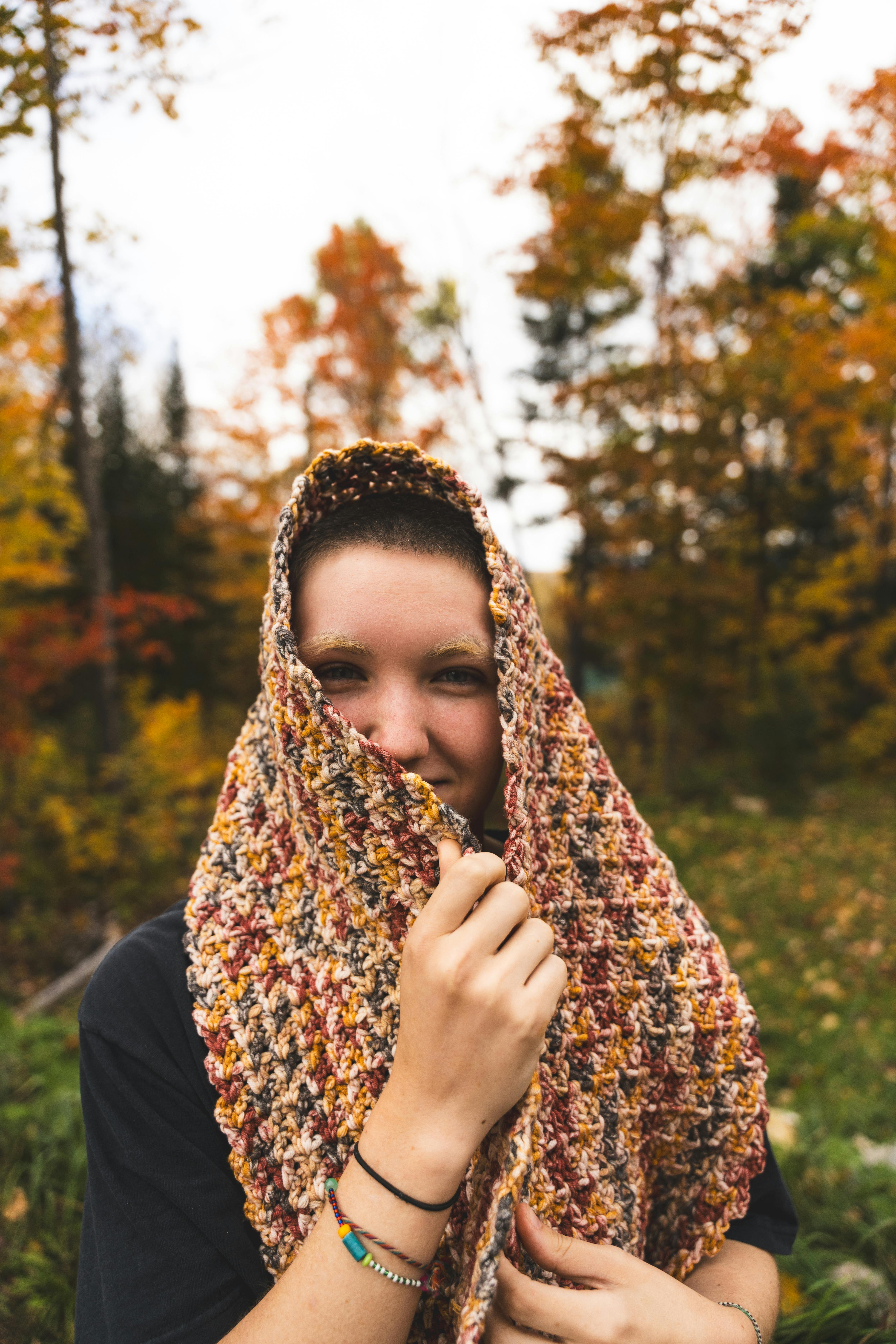 Young Person Smiling with Colorful Autumn Scarf · Free Stock Photo